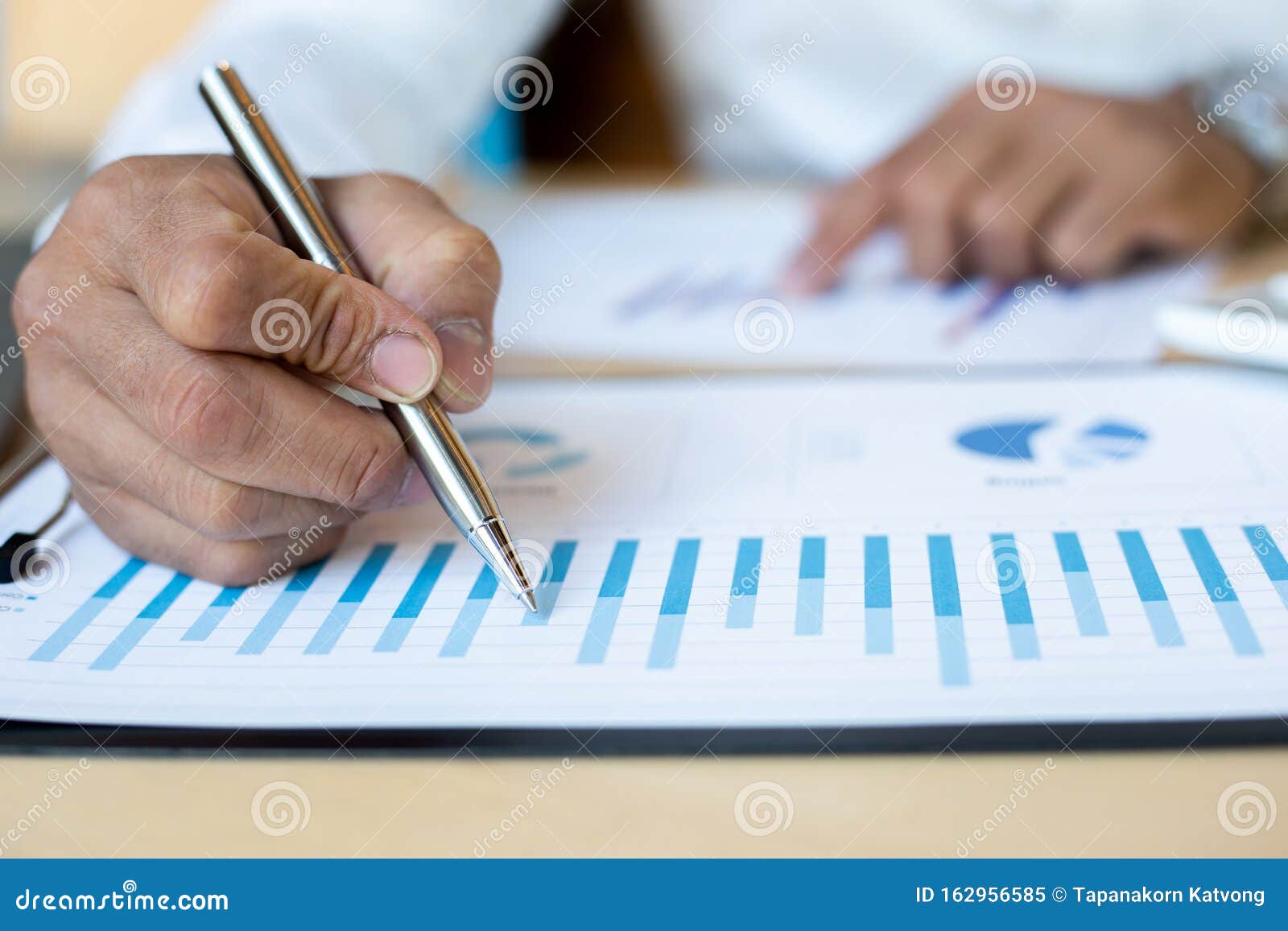 A Financial Businessman, a Young Man Analyzes Financial Data Using a ...