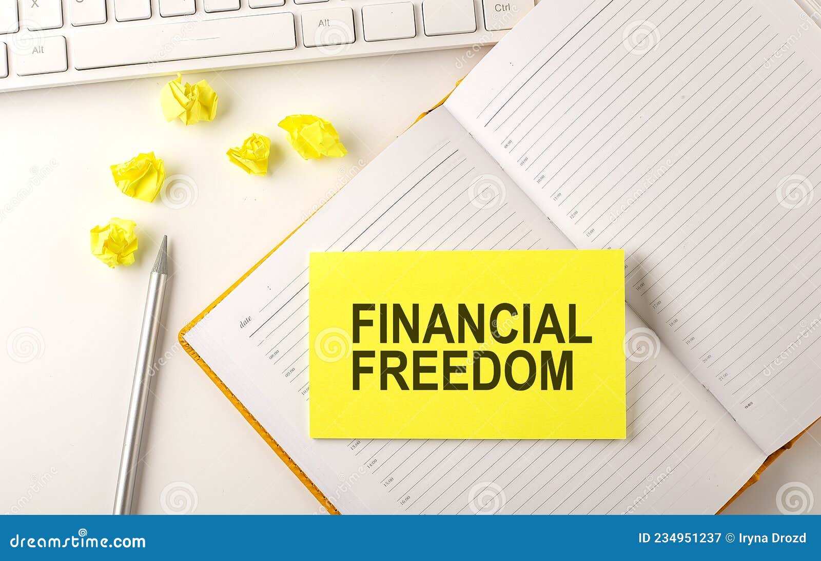 FINANCIAL FREEDOM Text on Sticker on the Diary with Keyboard and Pencil ...