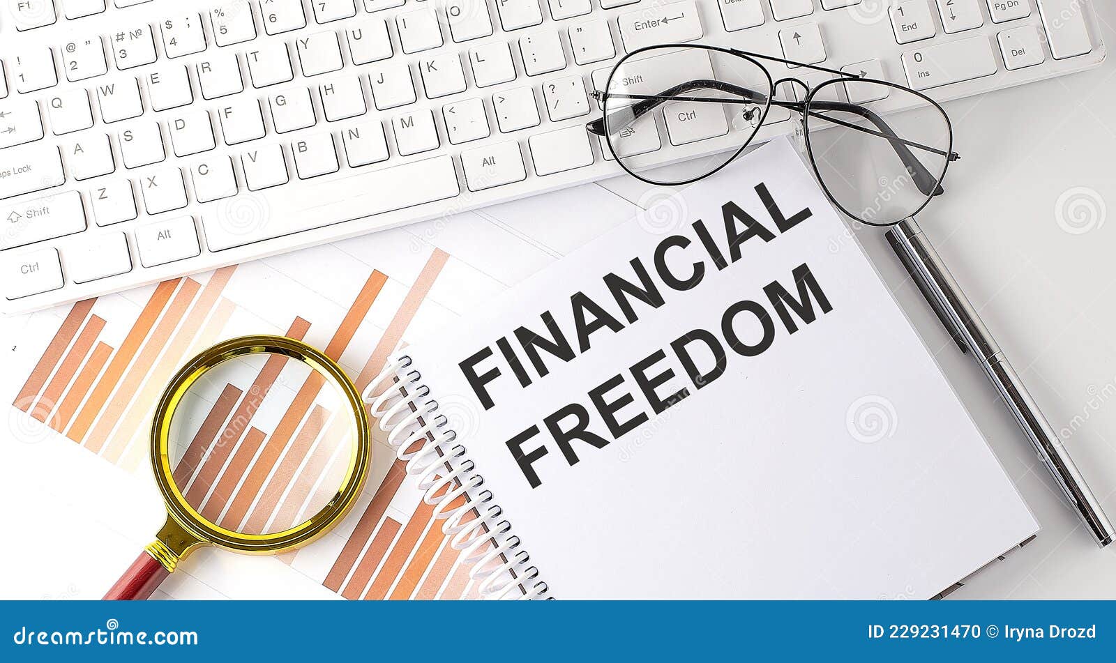 FINANCIAL FREEDOM Text Written on a Notebook with Keyboard, Chart,and ...