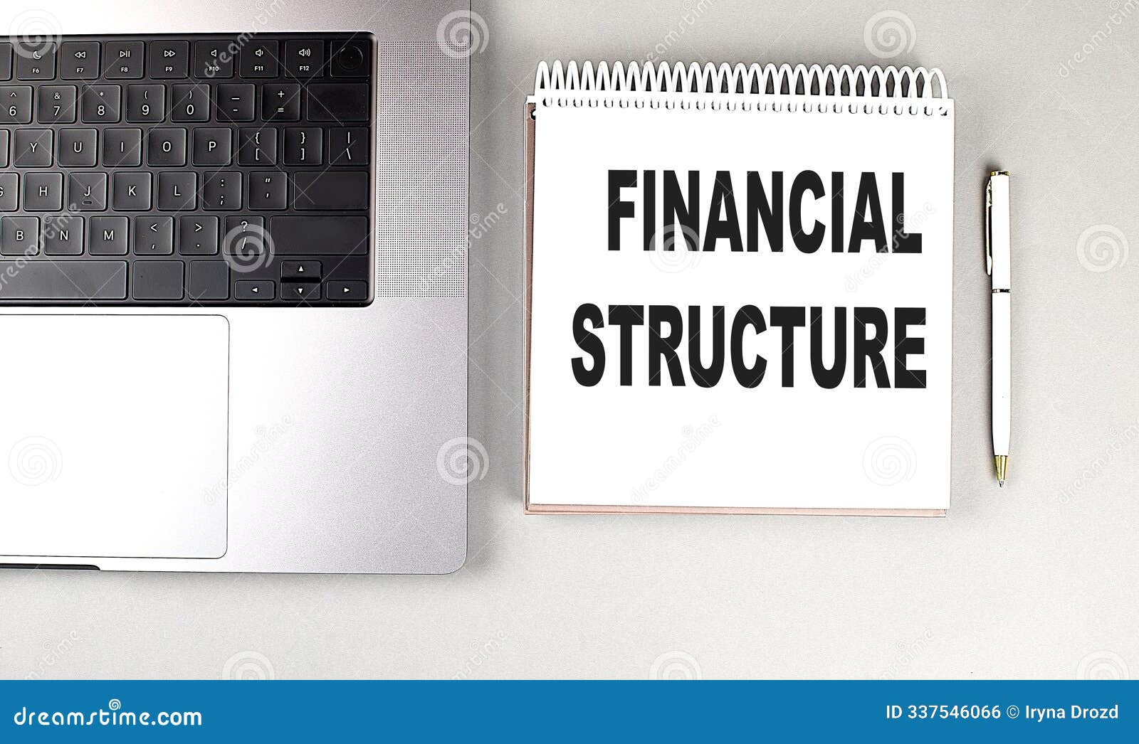Financial Structure Text on Spiral Notebook with Laptop and Pen on Grey ...