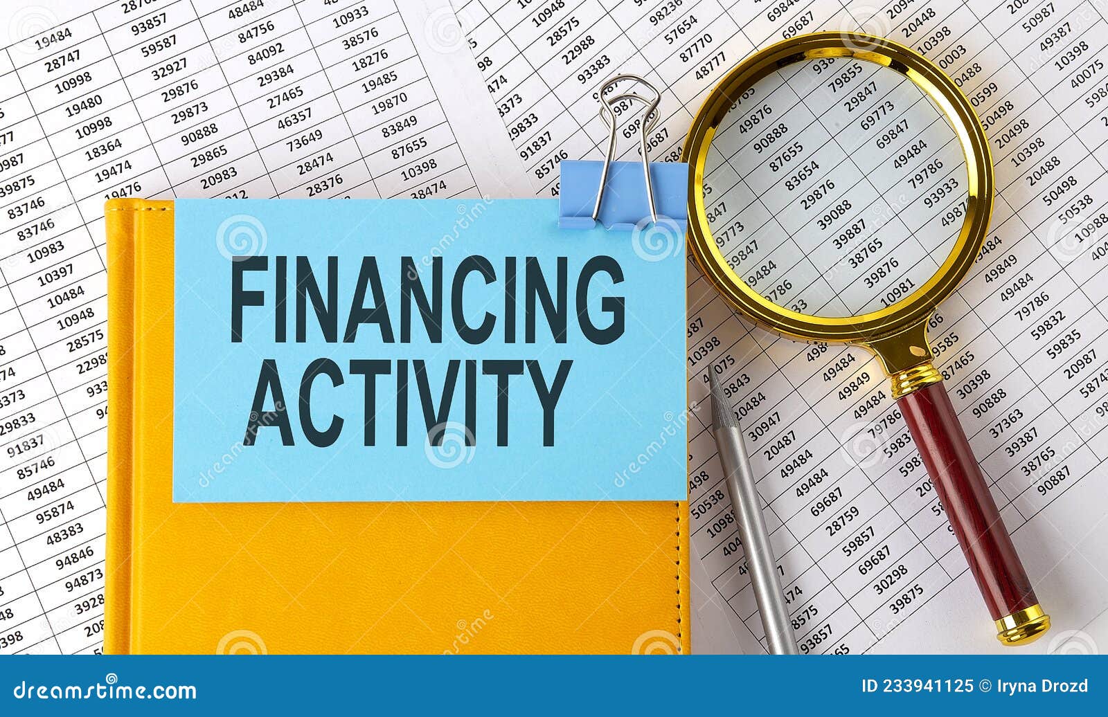 FINANCING ACTIVITY Text on Sticker on Notebook with Magnifier and Chart ...