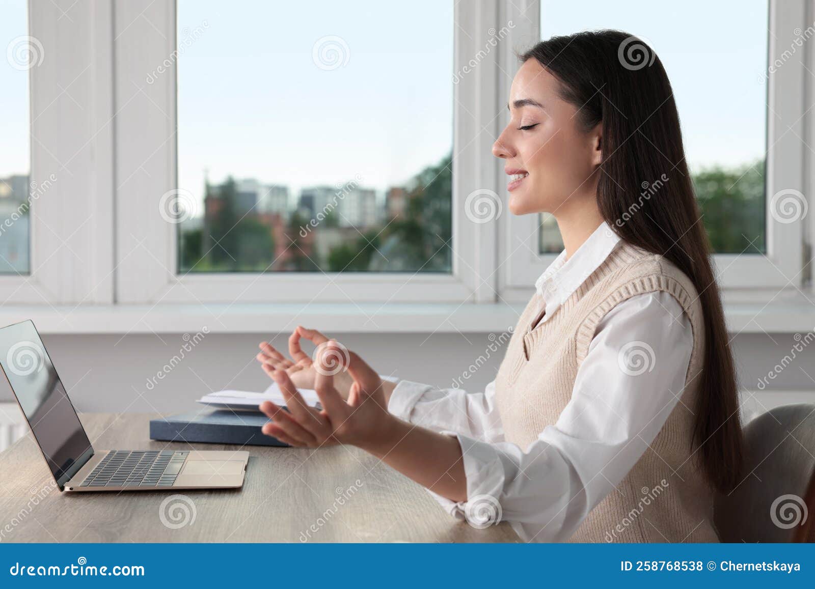 Find Zen. Woman Taking Break from Work at Table in Room Stock Photo ...