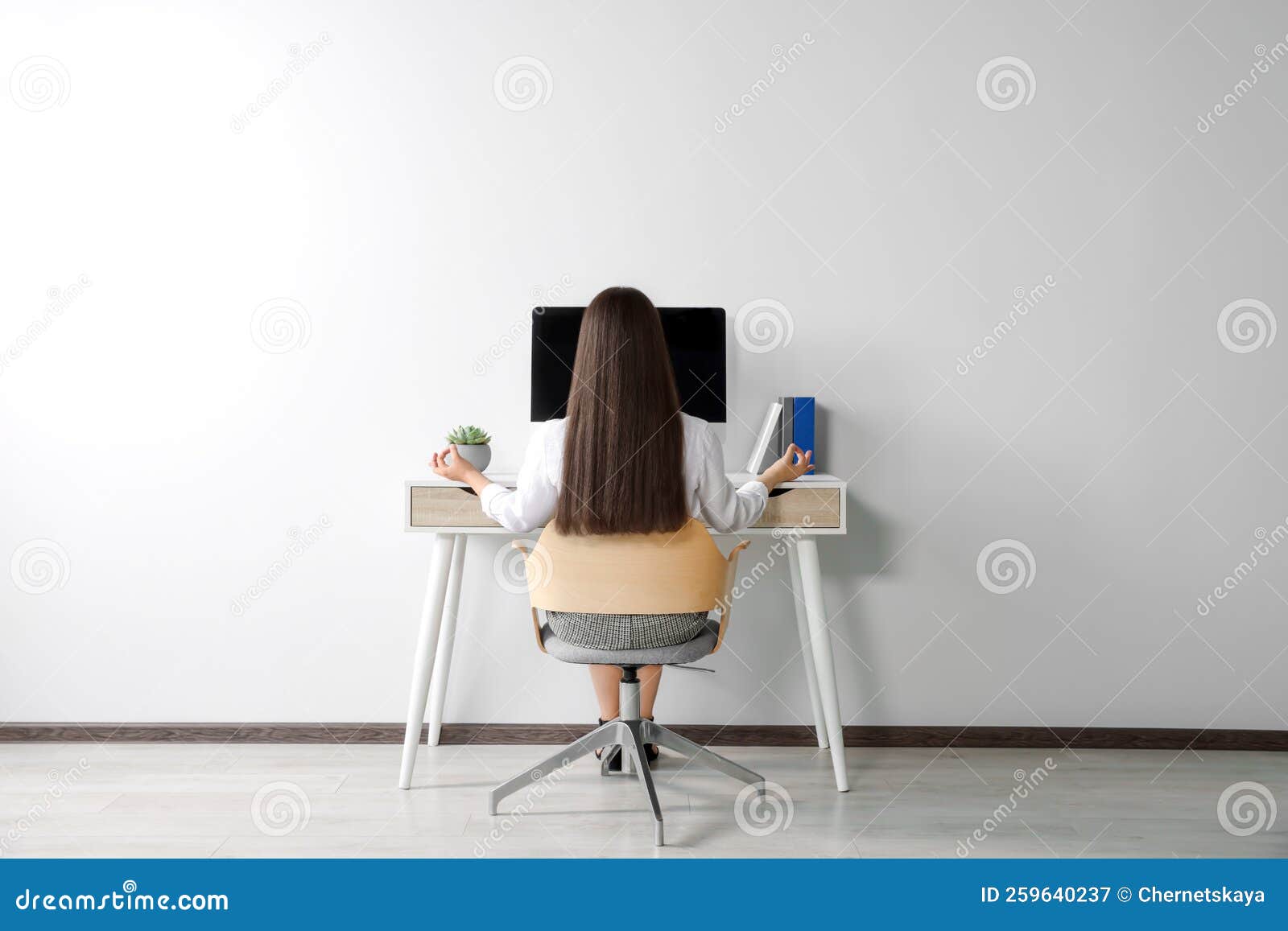 Find Zen. Woman Taking Break from Work at Table in Room, Back View ...
