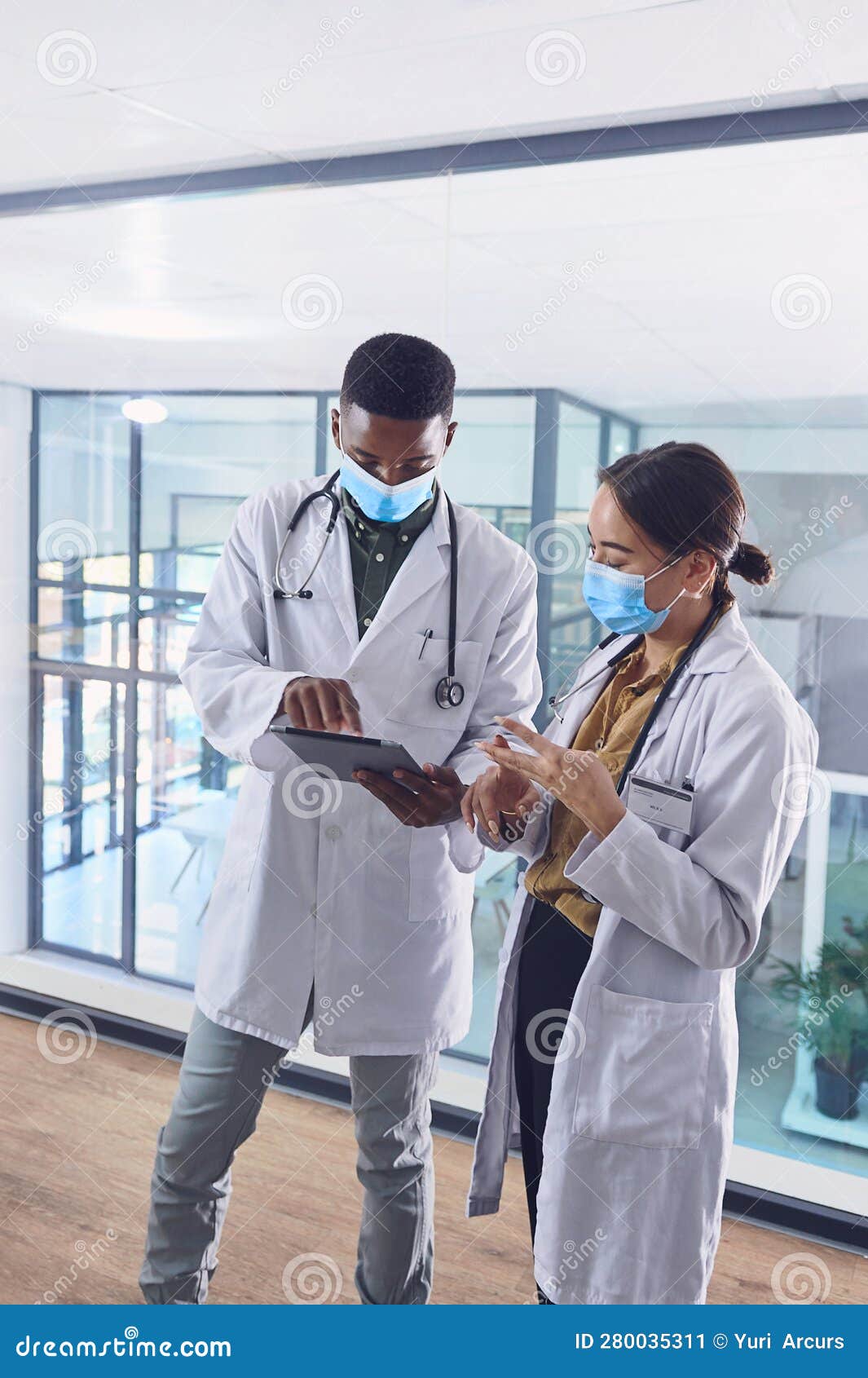 Finding a Solution Together. Two Young Doctors Working on a Digital ...