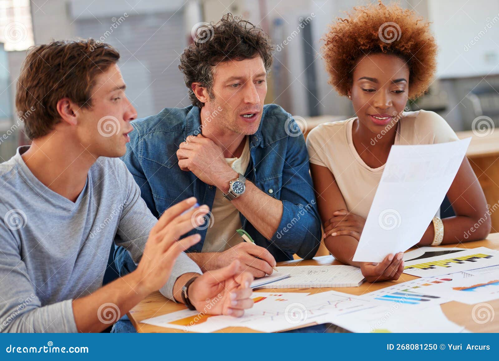 Fine Tuning Their Ideas. a Group of Colleagues Collaborating with Each ...