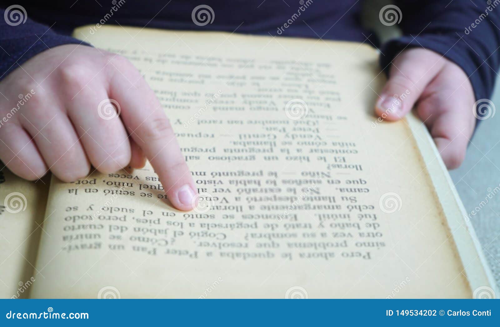 Finger of a girl on a book stock photo. Image of paper - 149534202
