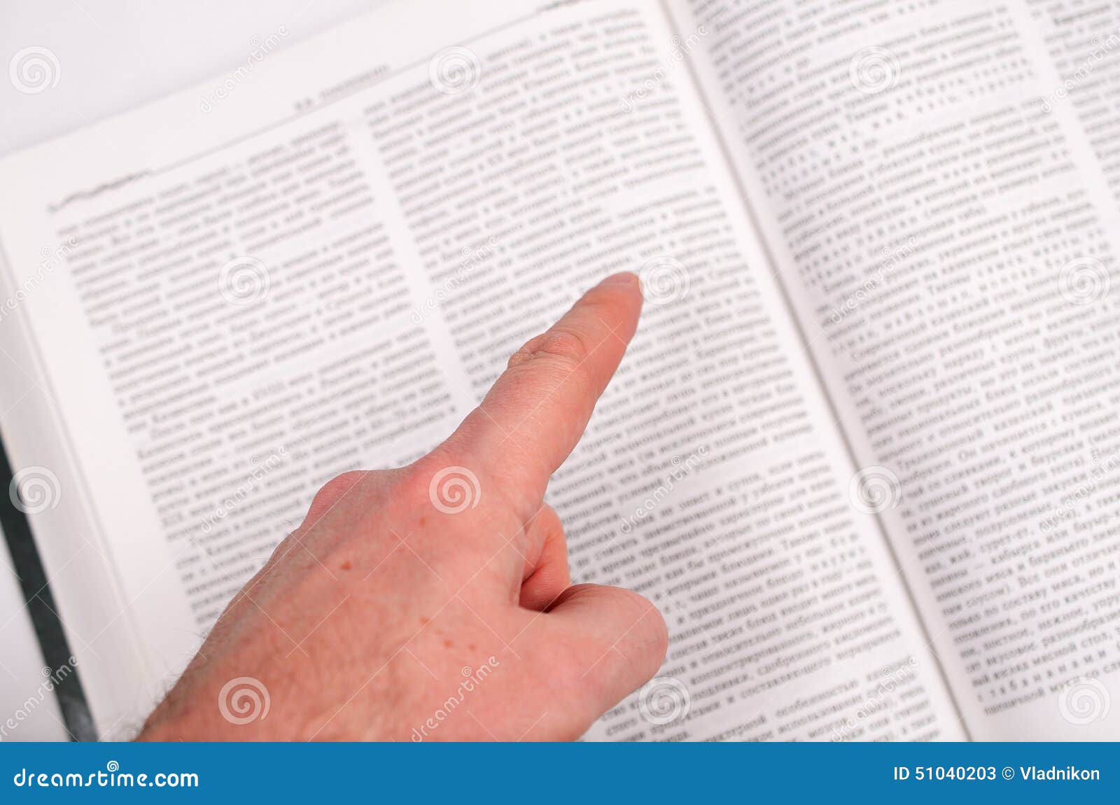 Finger hows an open book. stock image. Image of document - 51040203