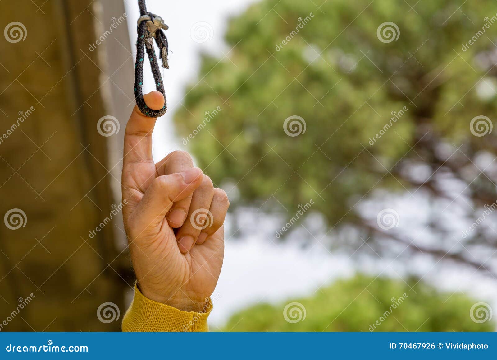Finger pulling eyelet stock photo. Image of tree, hand - 70467926