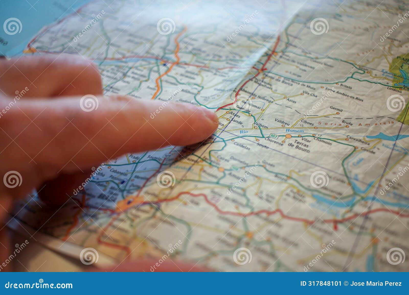 A finger in a road map stock image. Image of concept - 317848101
