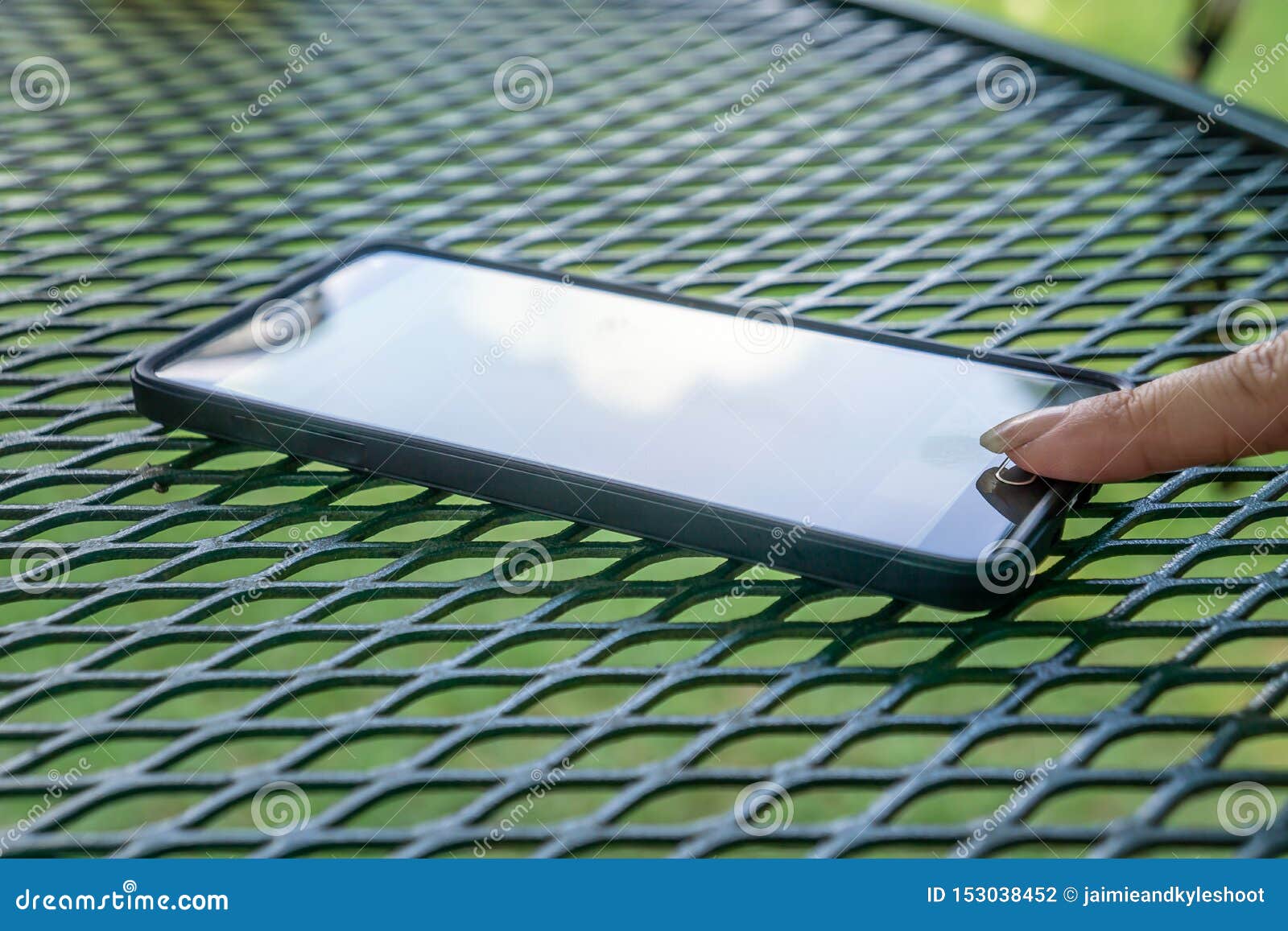 Finger Tapping on Off Button on Smart Cell Phone. Outside Resting on ...