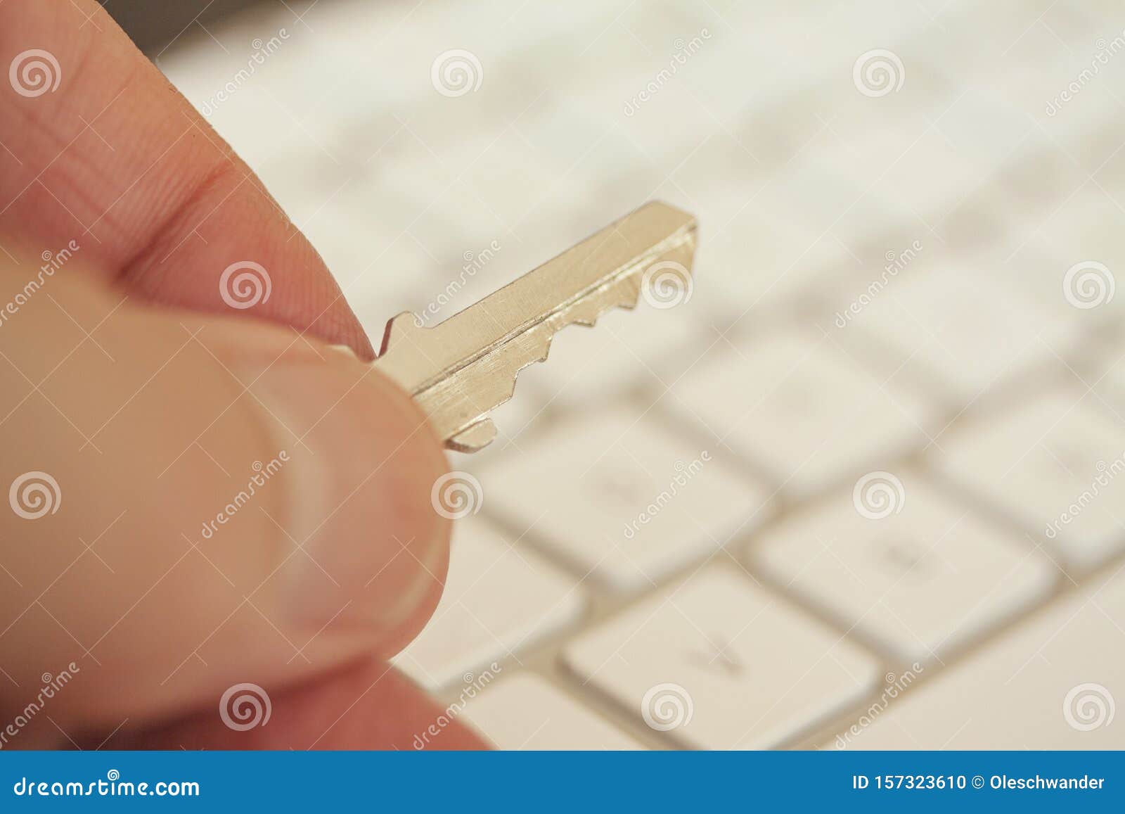 Fingers Holding a Key in Front of a Computer Keyboard. PC Network ...