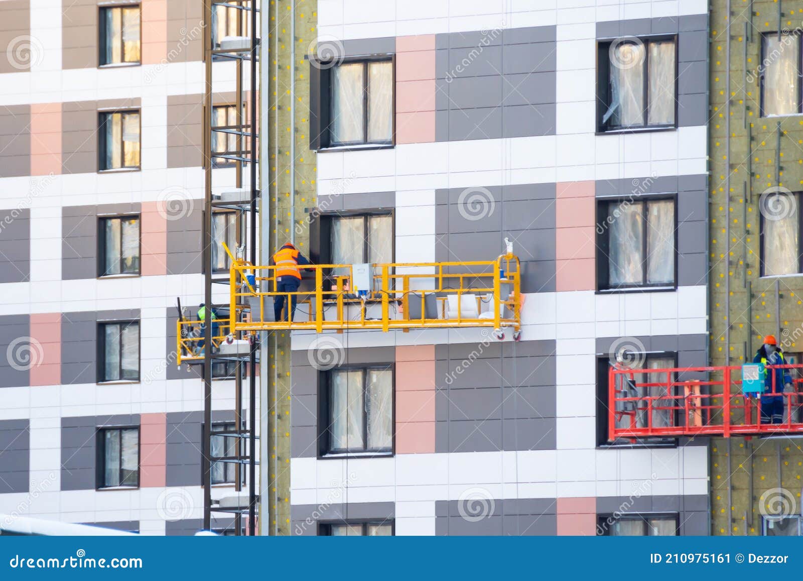 Finishing the Facade of Residential Buildings by Workers on the ...