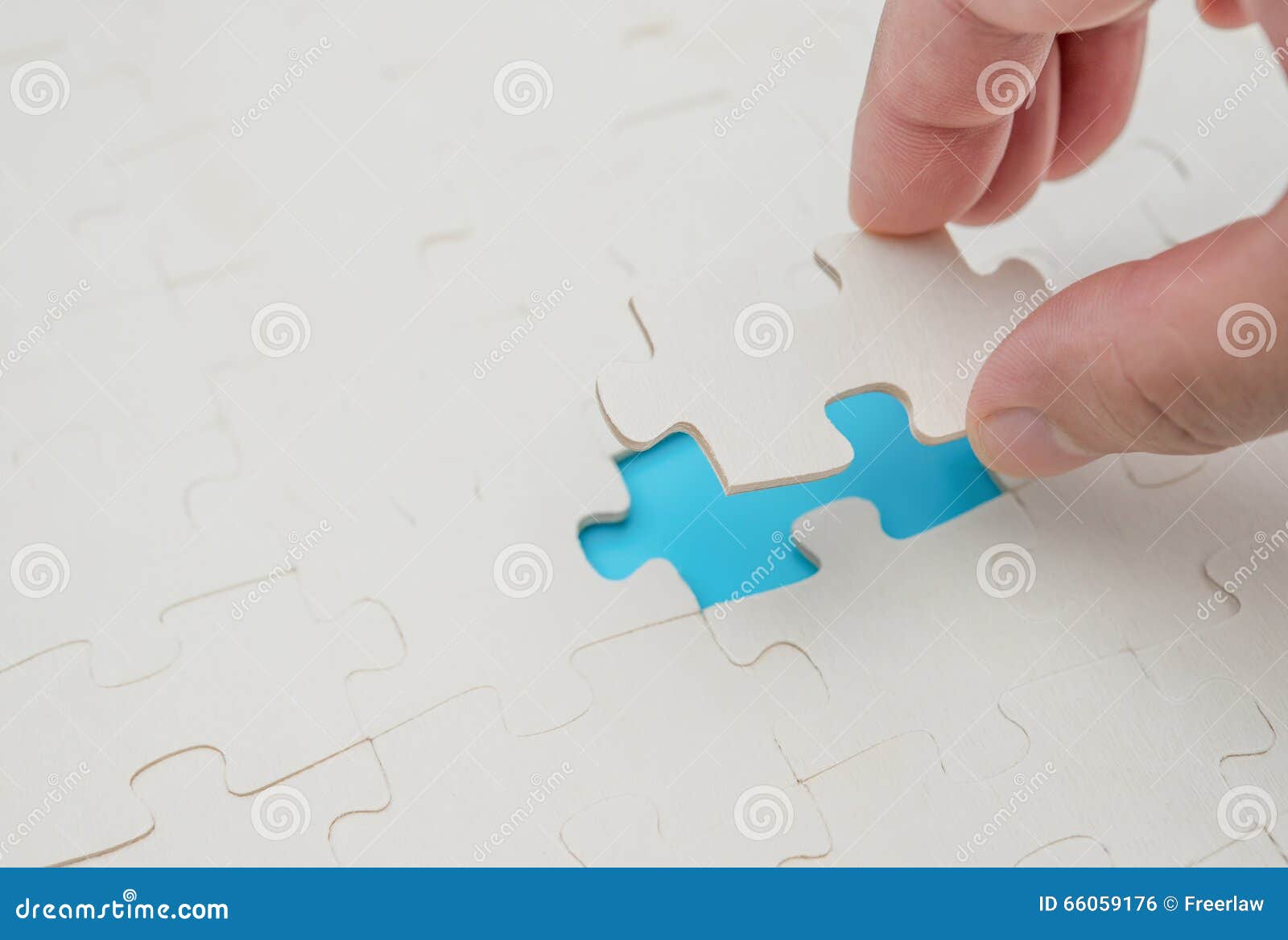 Finishing the Last Piece of Jigsaw Puzzle Game on Blue Stock Photo ...
