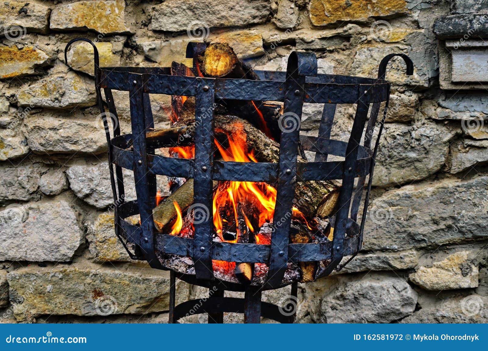 Fire in a fire basket stock photo. Image of flame, metal - 162581972