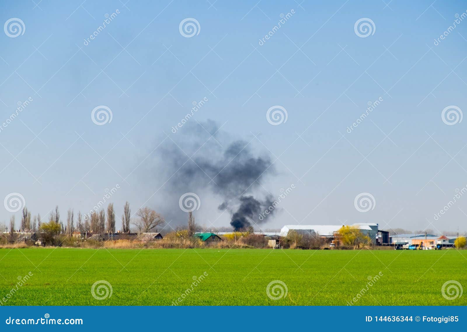 Fire and Black Smoke Outside the Village. Soot from Stock Photo - Image ...