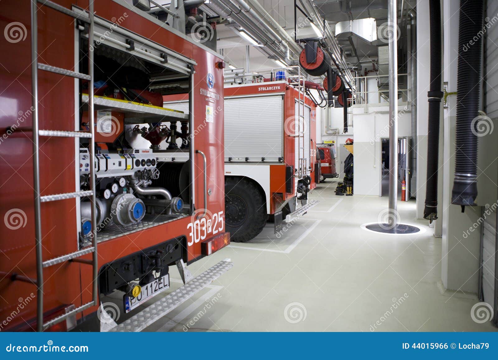 Fire Brigade Are At The Entrance Of An Apartment Building, Standing ...