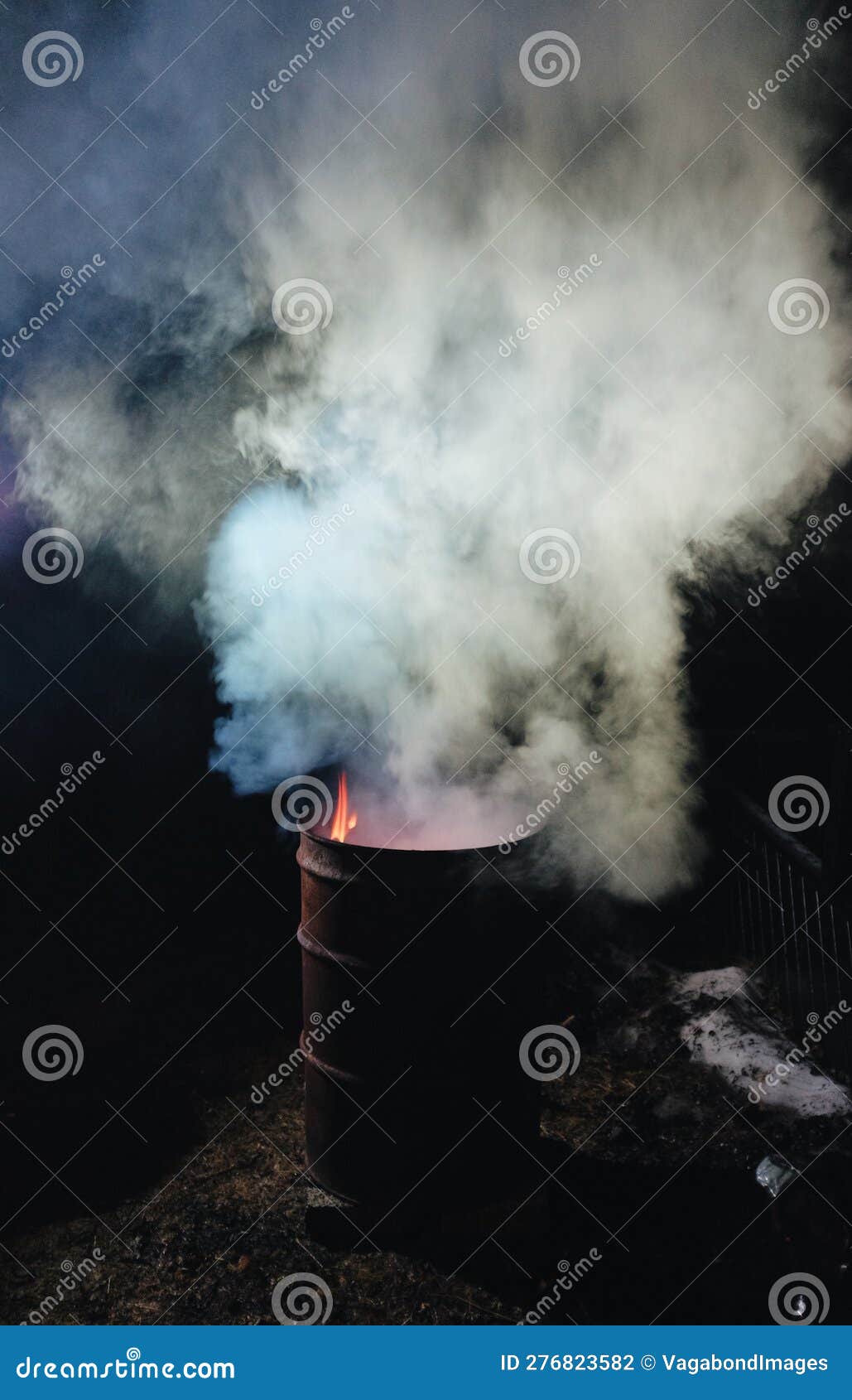Fire Burning Inside a Metal Barrel Stock Photo - Image of dark, metal ...