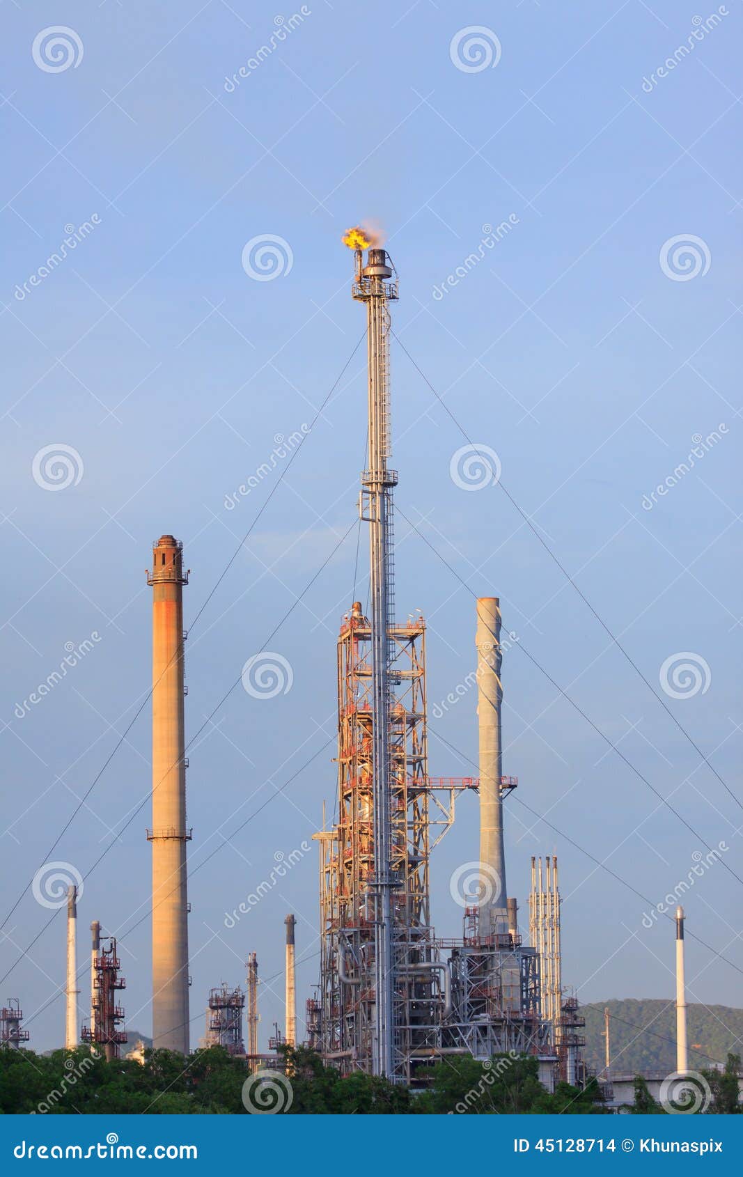Fire Burning Over Oil Refinery Chimney Against Blue Sky Stock Photo ...