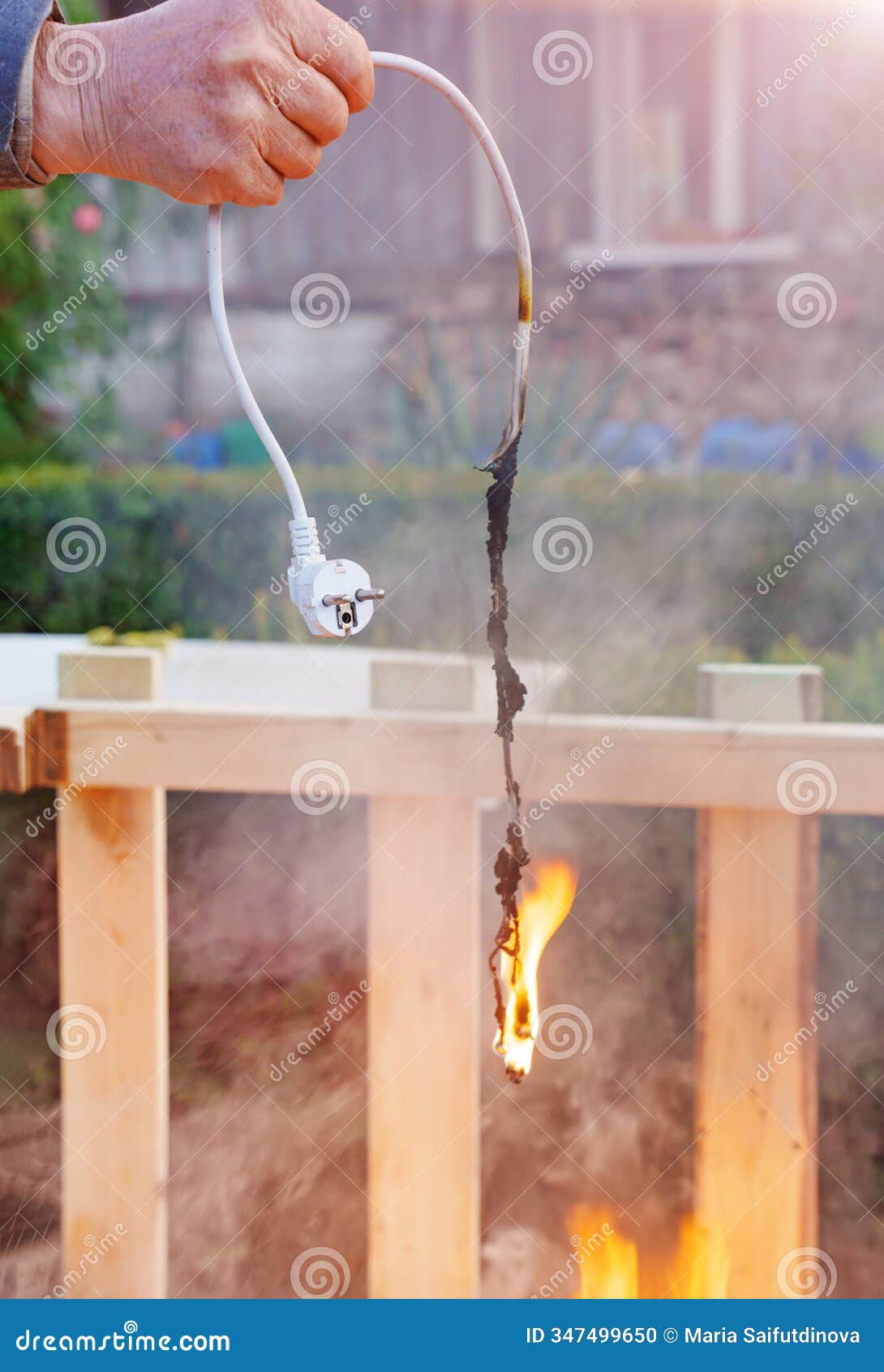 Fire on an Electric Wire with a Plug in the Hands of a Man. Stock Photo ...