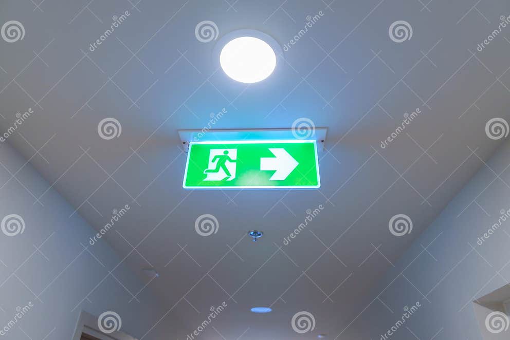 Fire Emergency Exit Sign on the Wall Background Inside Building. Safety ...