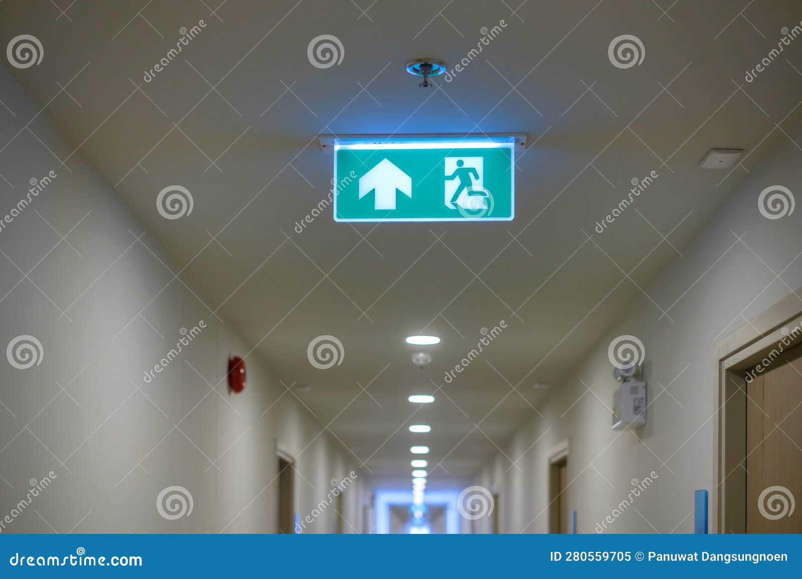 Fire Emergency Exit Sign on the Wall Background Inside Building. Safety ...