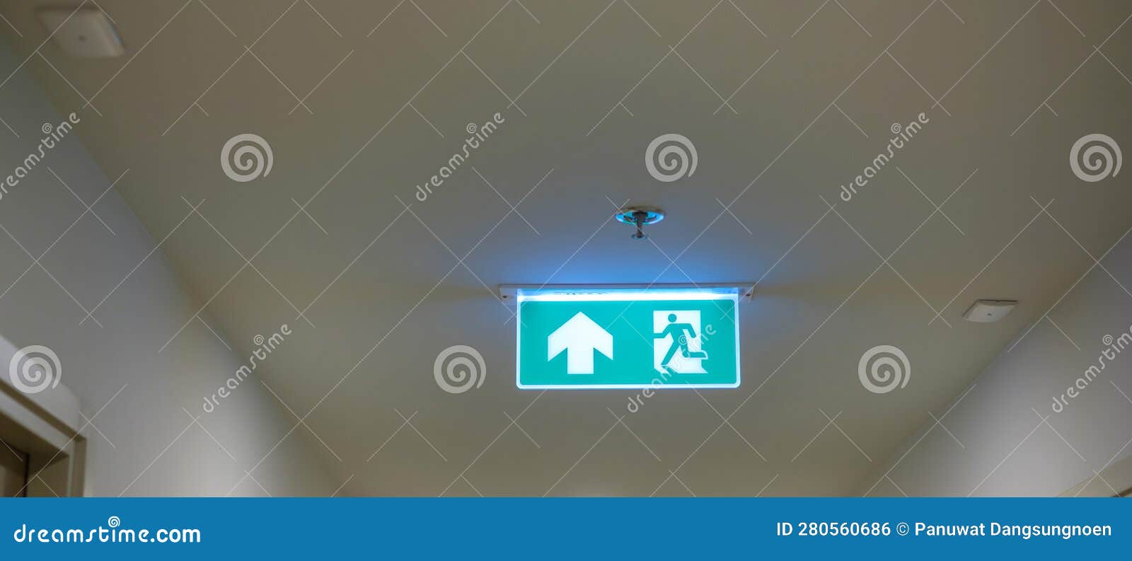 Fire Emergency Exit Sign on the Wall Background Inside Building. Safety ...