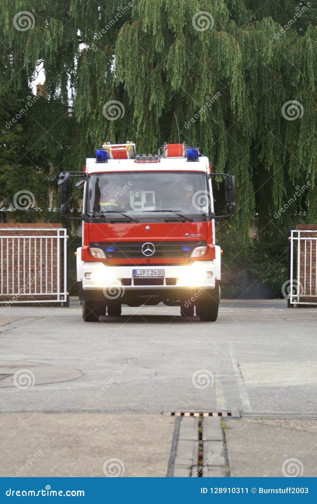 Fire engine on blue light editorial photo. Image of tender - 128910311