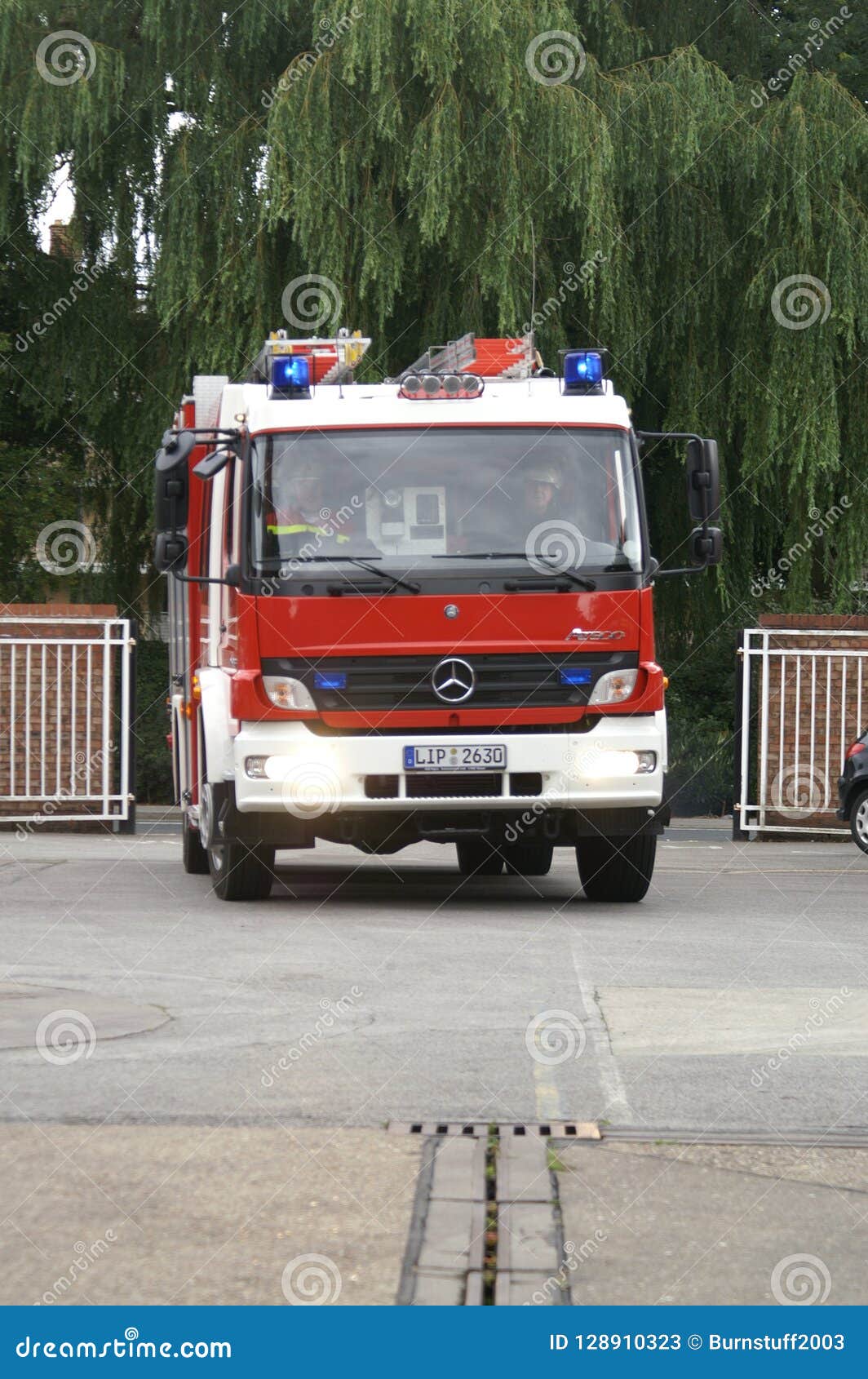 Fire engine on blue light editorial stock photo. Image of crash - 128910323