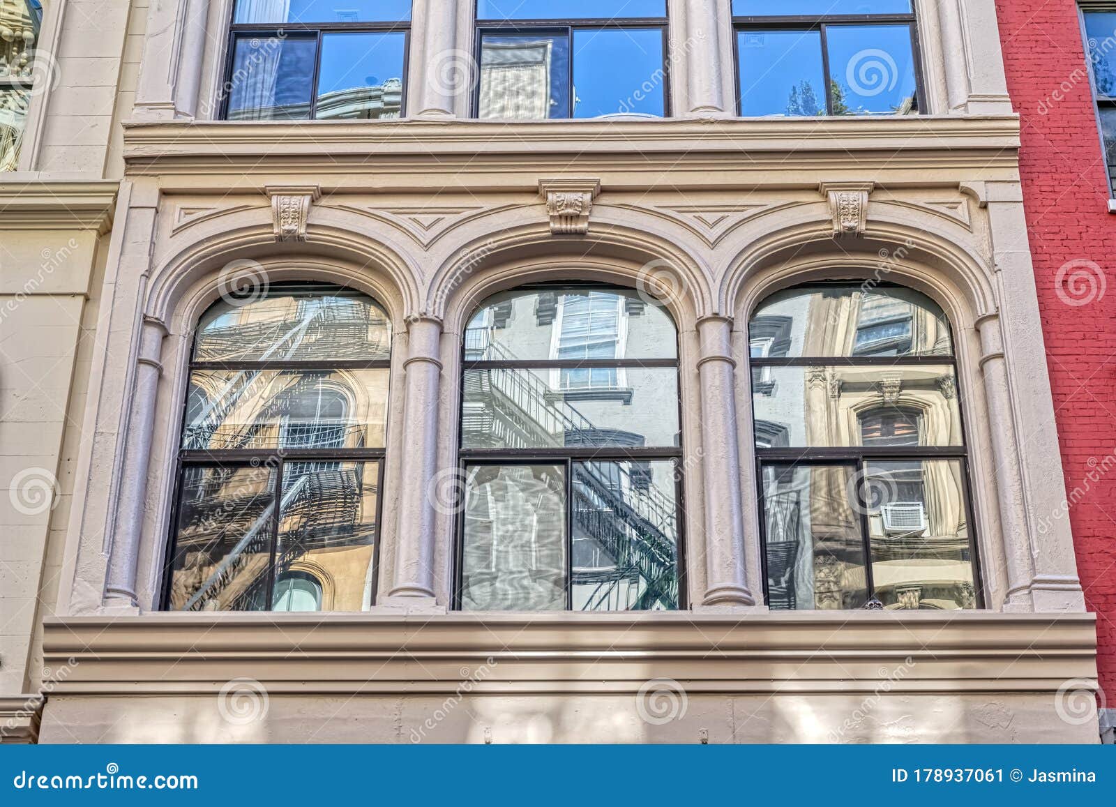 Fire Escape Reflections in the Old Stone Facade Windows in New York ...