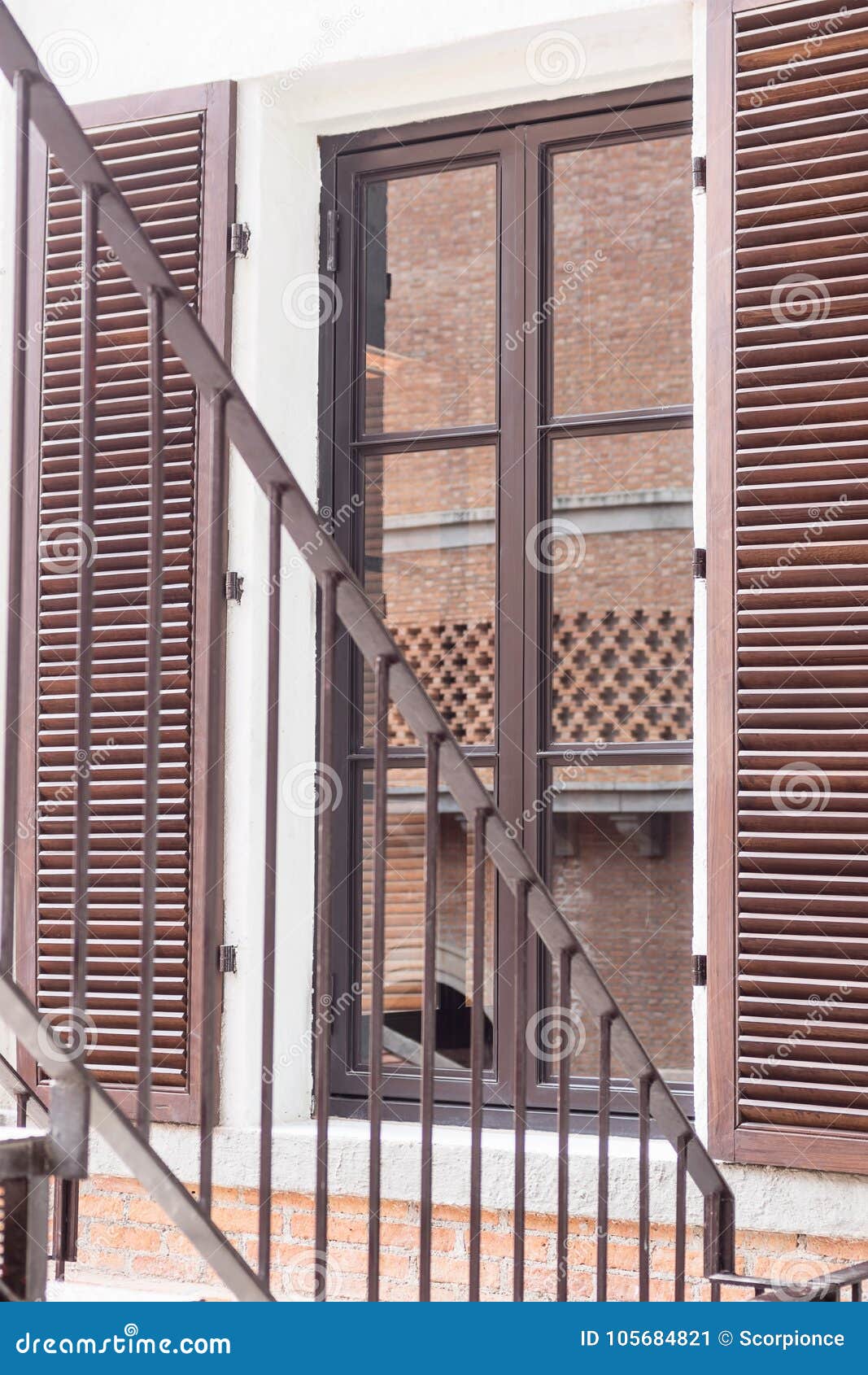 Fire Escape Stairs beside Window, Brick Wall in Glass Reflection ...