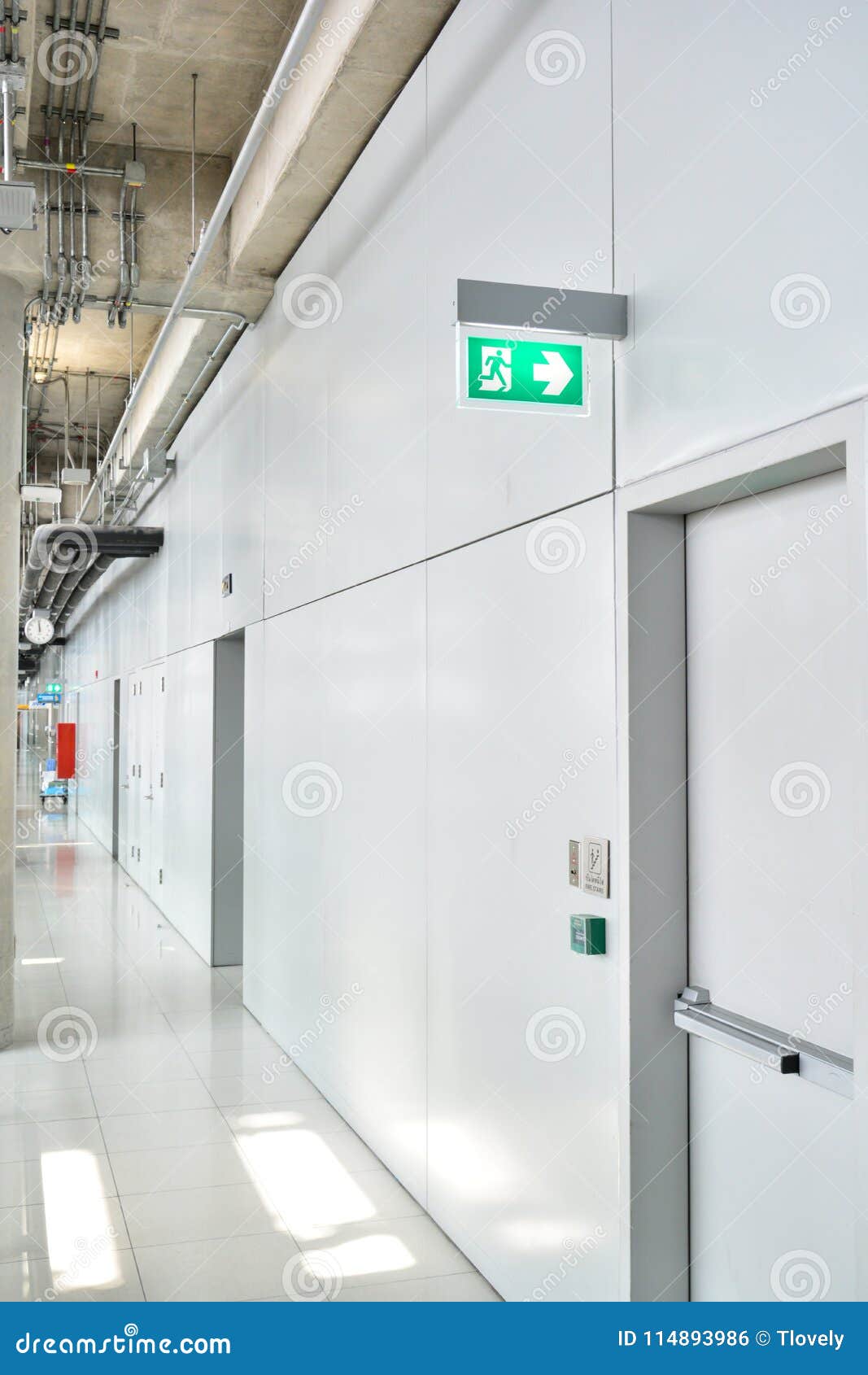Fire exit sign in factory stock photo. Image of doorway - 114893986