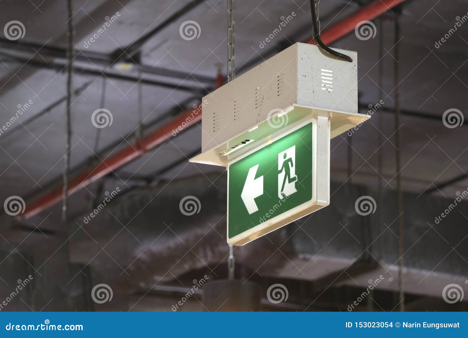 Fire Exit Sign Hanging on Top of the Building. Fire Exit Sign Stock ...