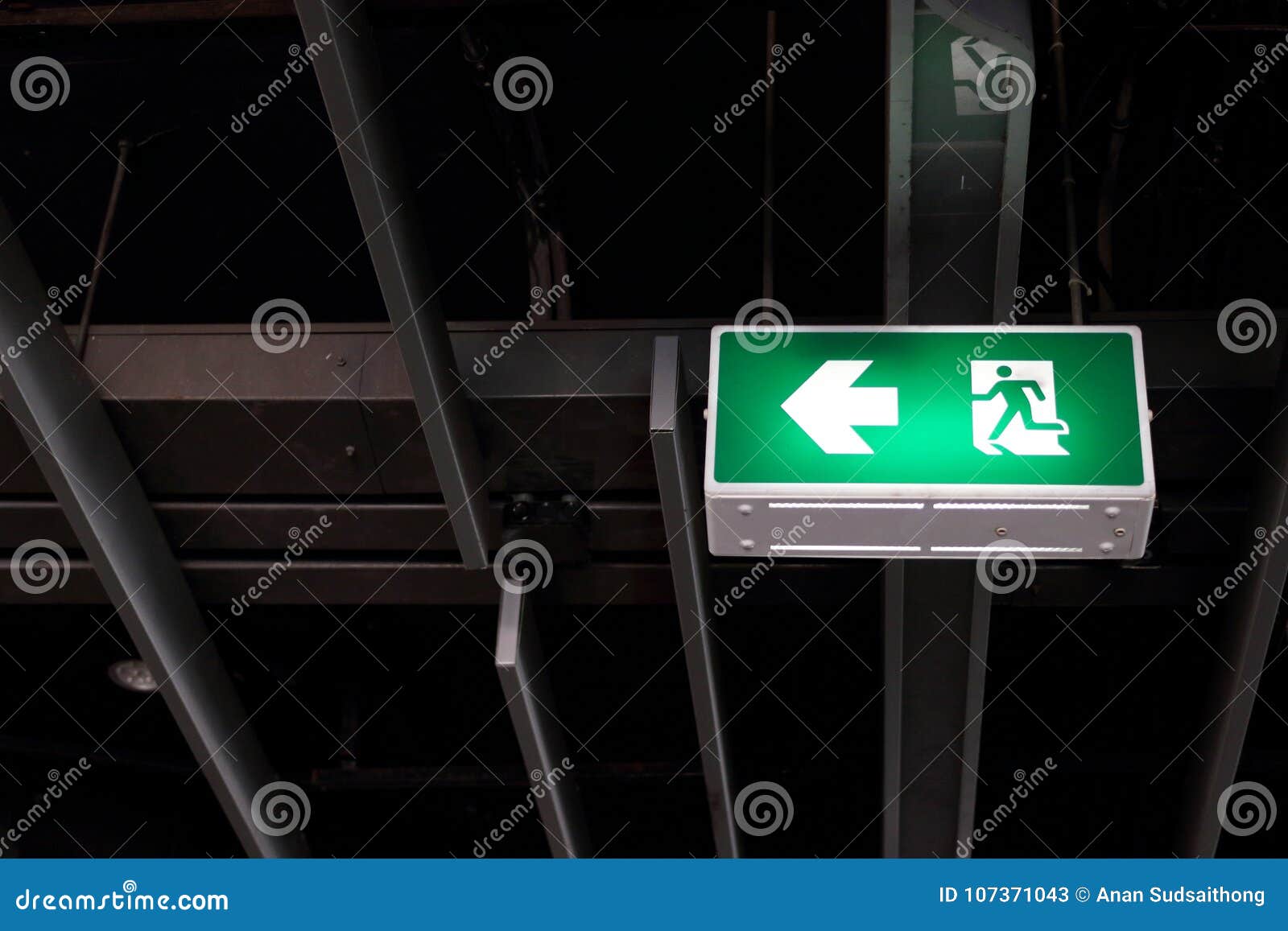 Fire Exit Sign Hanging Under Ceiling. Selective Focus and Shallow Depth ...