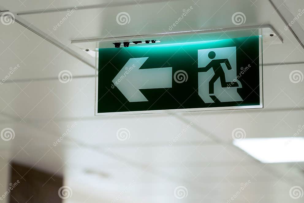 Fire exit sign stock image. Image of rescue, glare, wall - 147269691