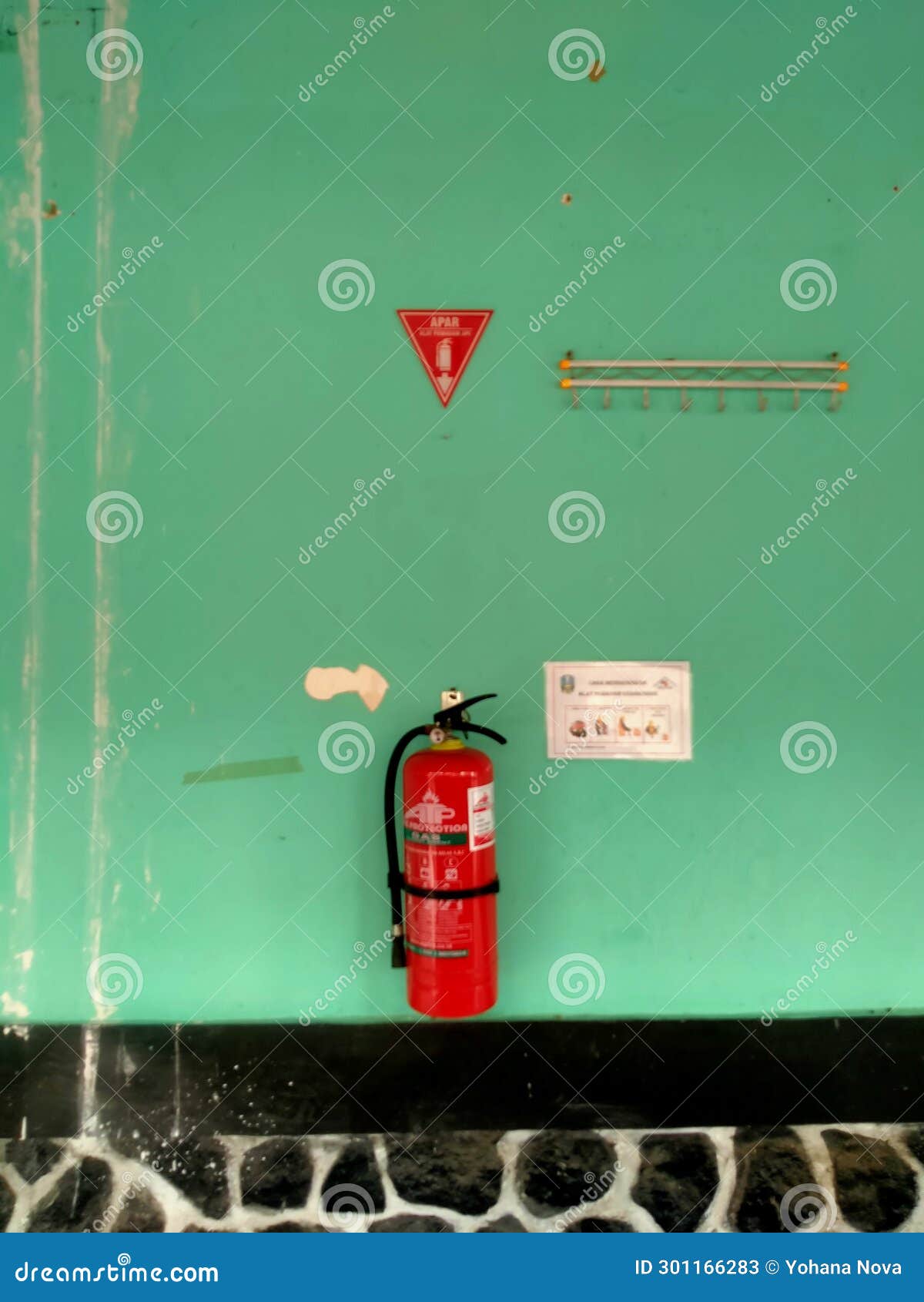 The Fire Extinguisher with Caution Hang on the Blue Wall Editorial ...