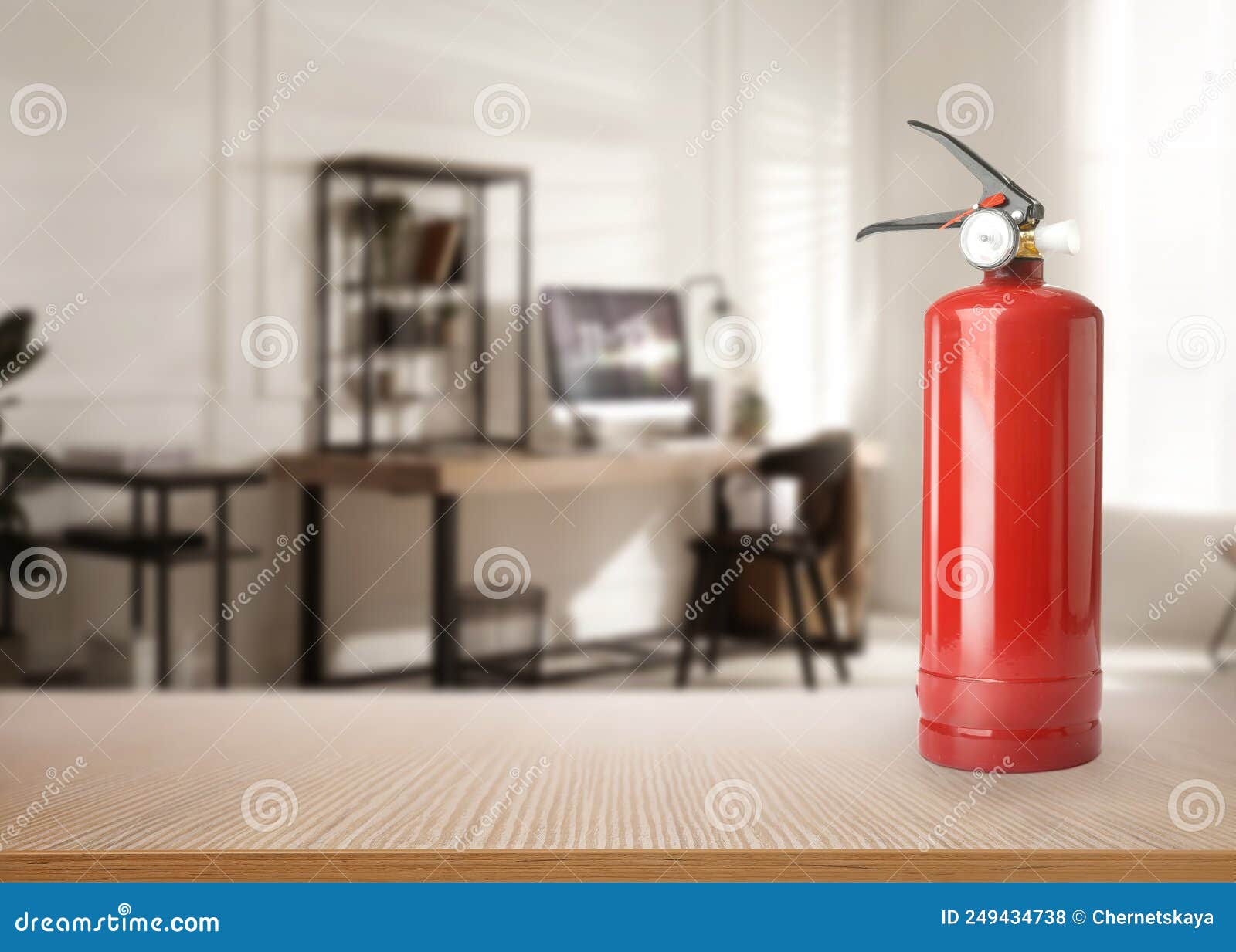 Fire Extinguisher on Wooden Table in Office. Space for Text Stock Photo ...