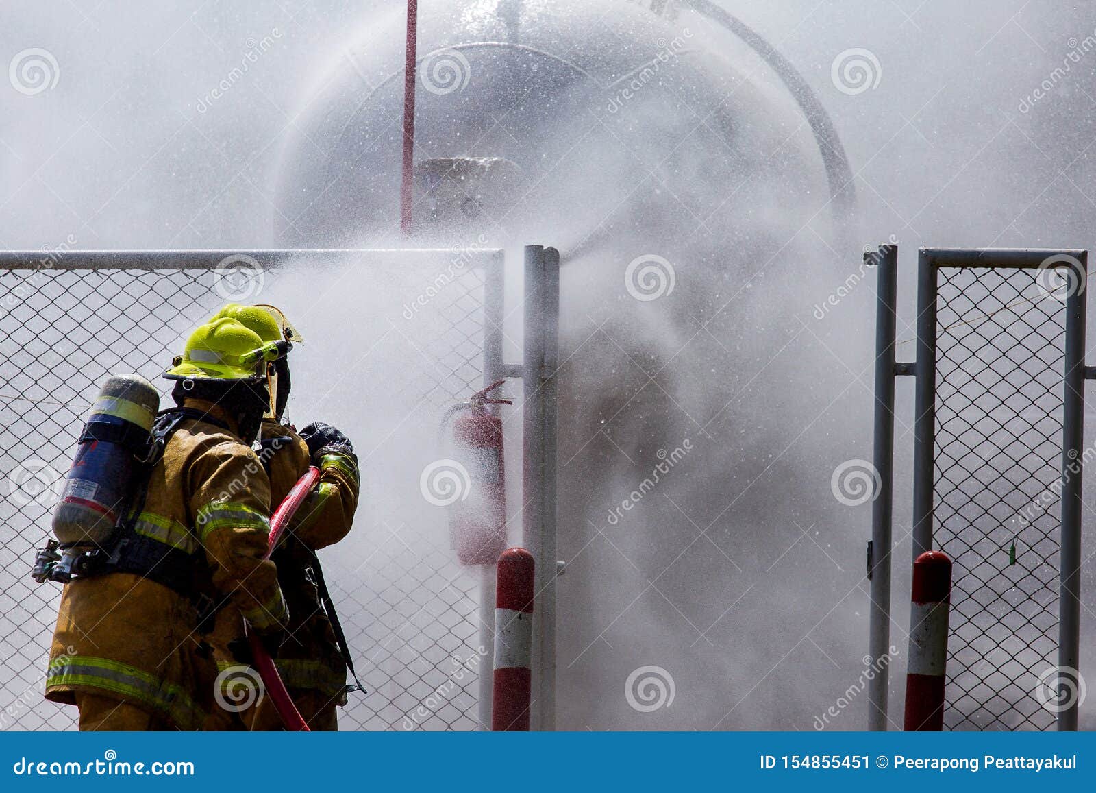 A Fire Fighter is Controlling a Fire Stock Image - Image of extinguish ...