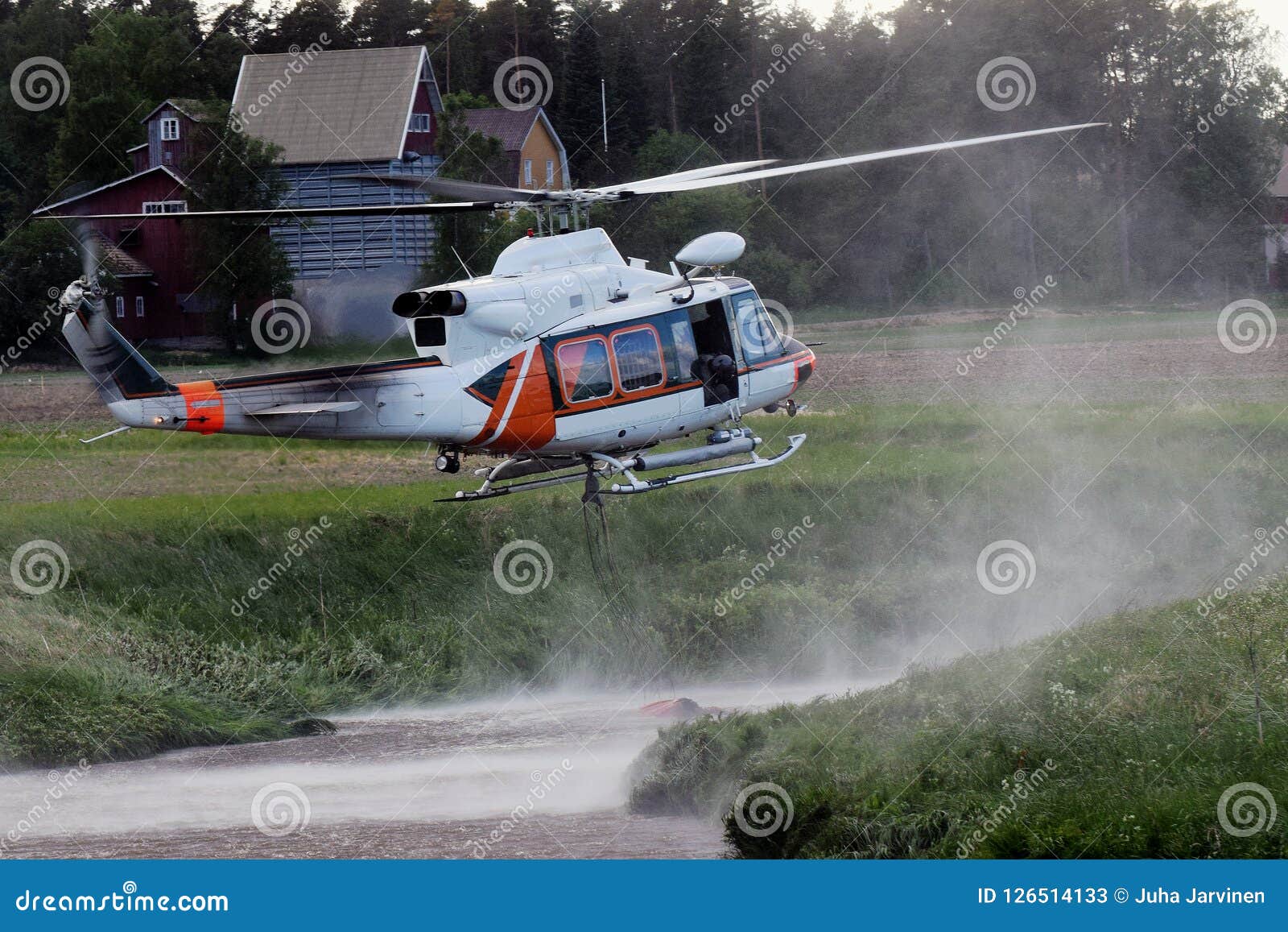 Fire Fighter Helicopter Hovering Over a Small River Stock Image - Image ...