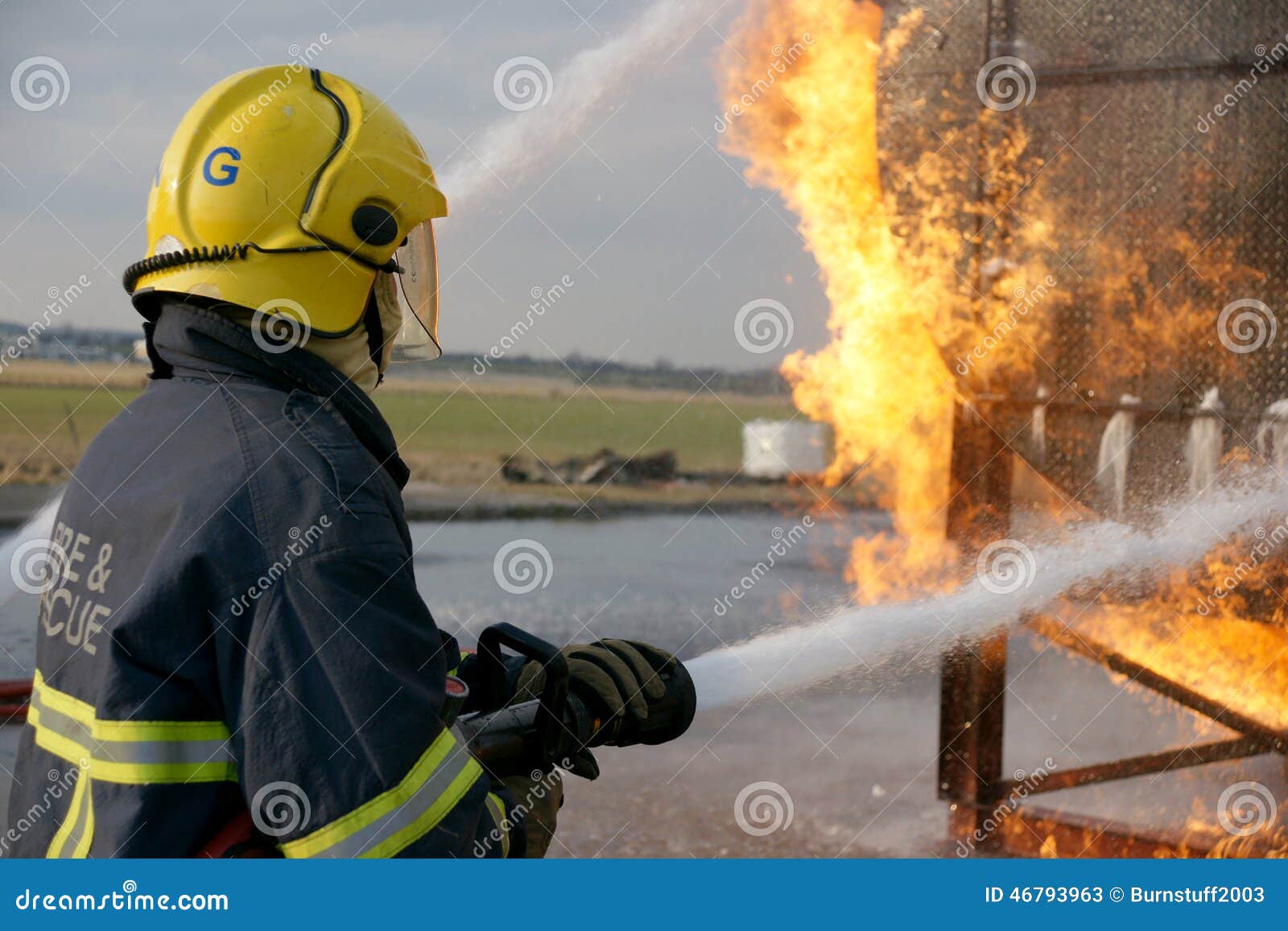 Fire fighter with hose editorial stock photo. Image of response - 46793963