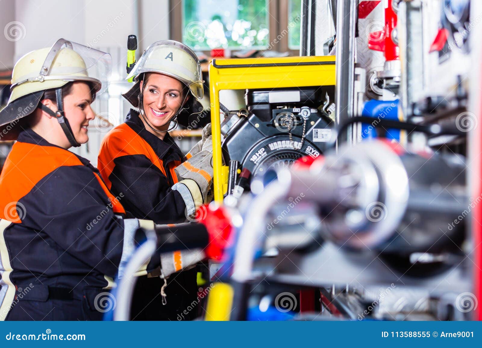 Fire Fighters Loading Hoses into Operations Vehicle Stock Image - Image ...