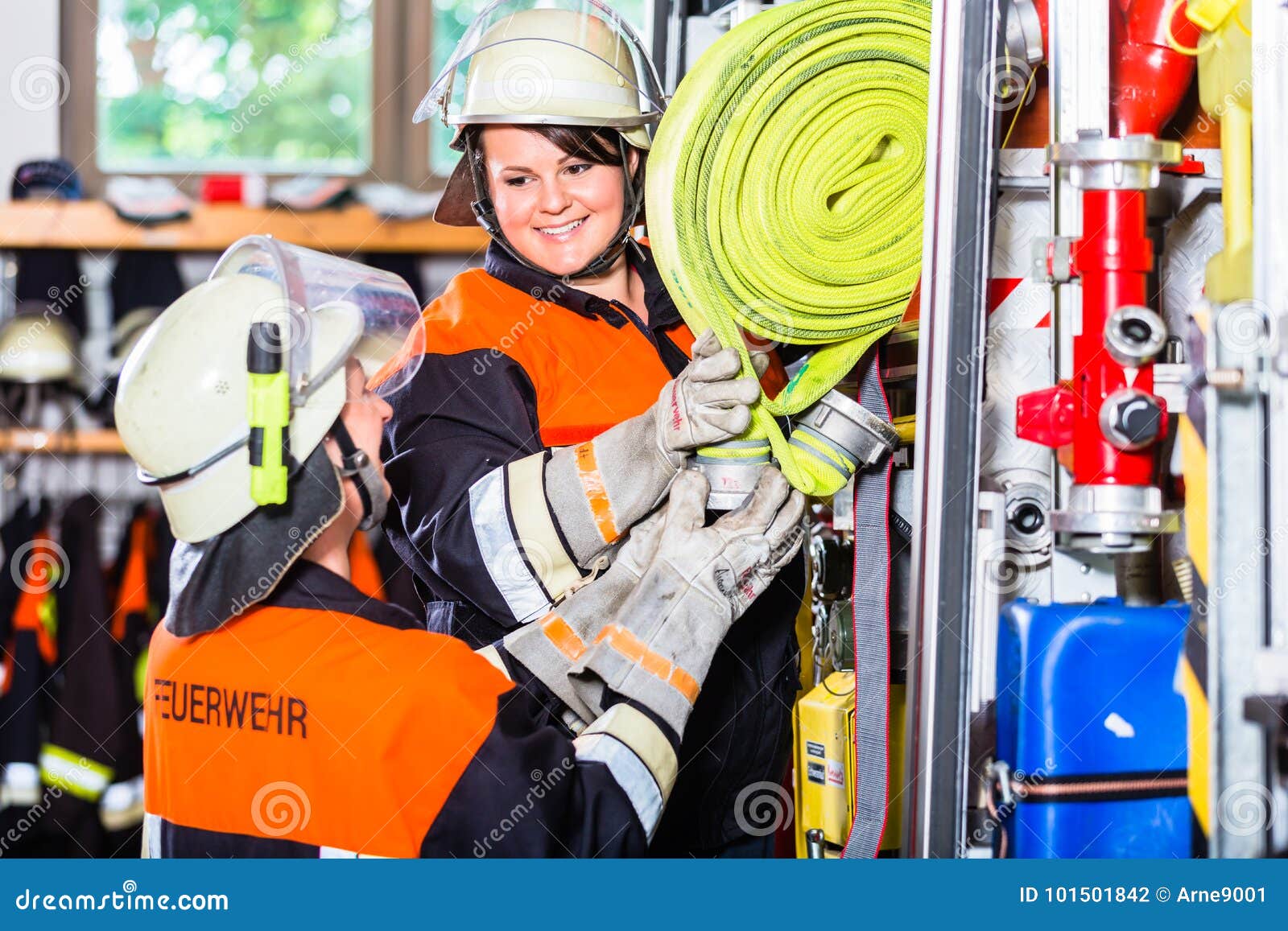 Fire Fighters Loading Hoses into Operations Vehicle Stock Photo - Image ...