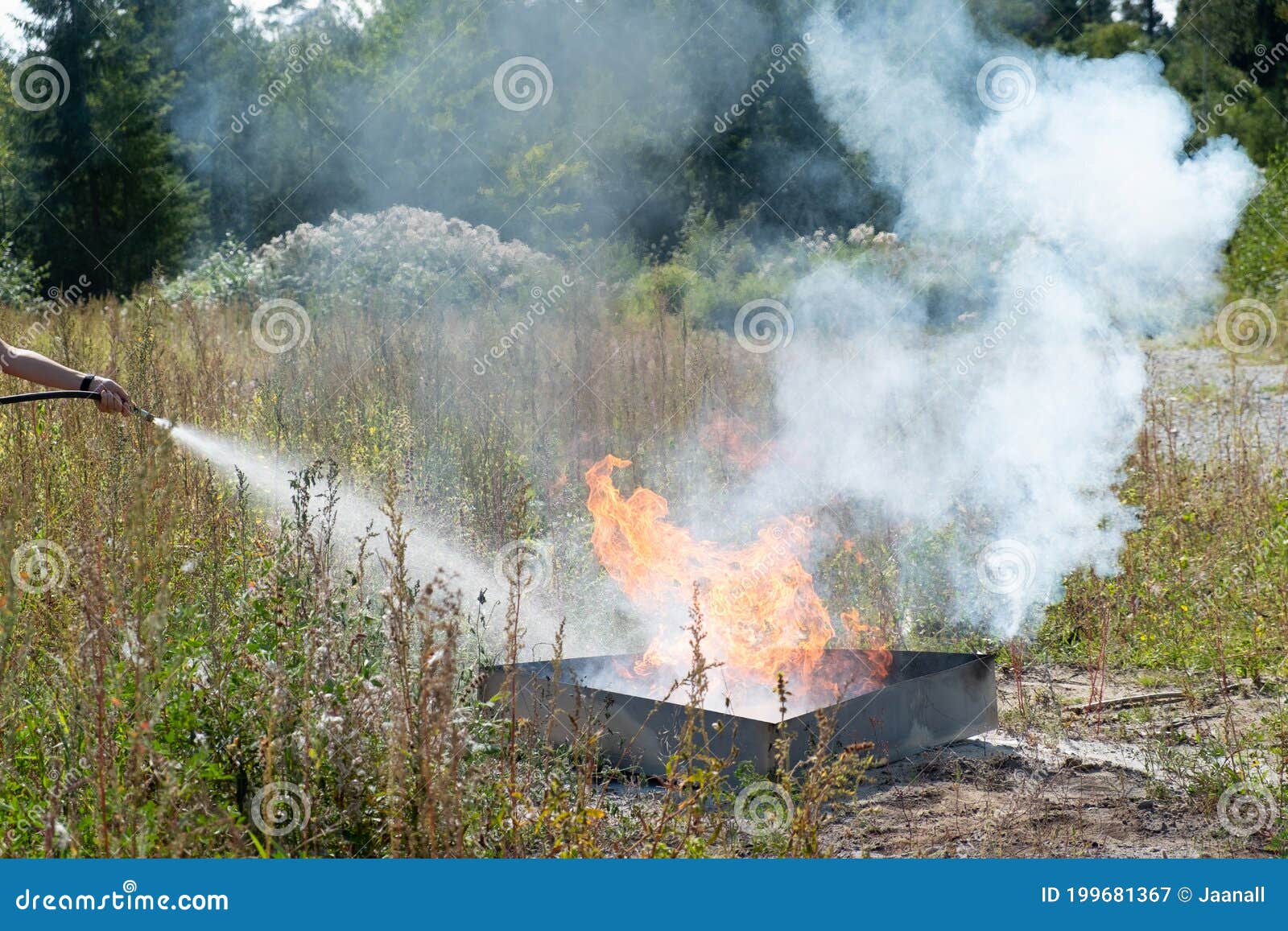 Fire Fighting Training on a Field Outdoors Stock Image - Image of flame ...
