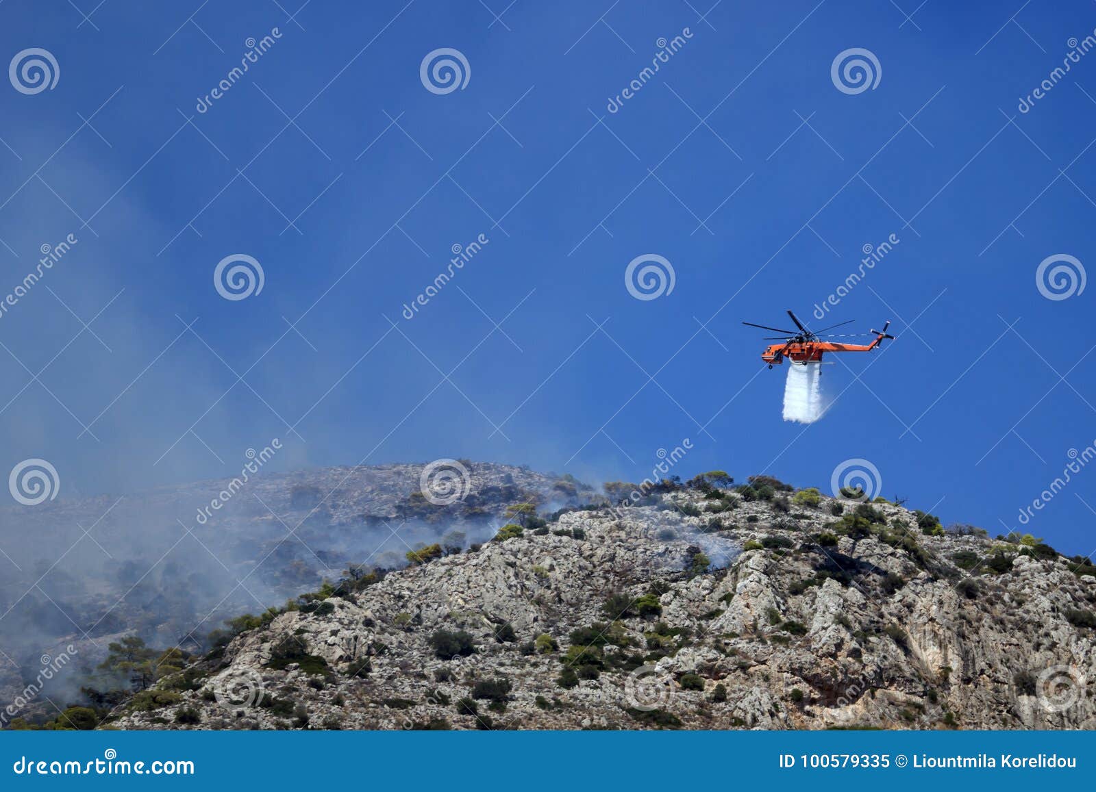 Fire Helicopter Extinguishes the Fire on the Hillside . Greece. Stock ...