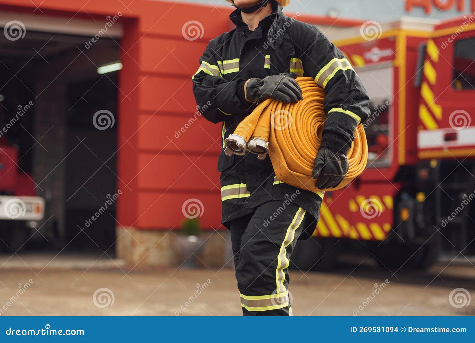 With Fire Hose in Hands. Woman in Uniform is at Work in Department ...