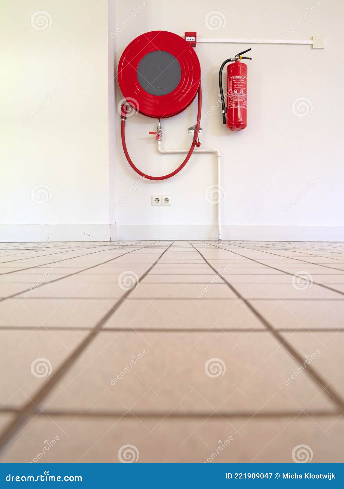 Fire hose on a wall stock image. Image of wall, emergency - 221909047