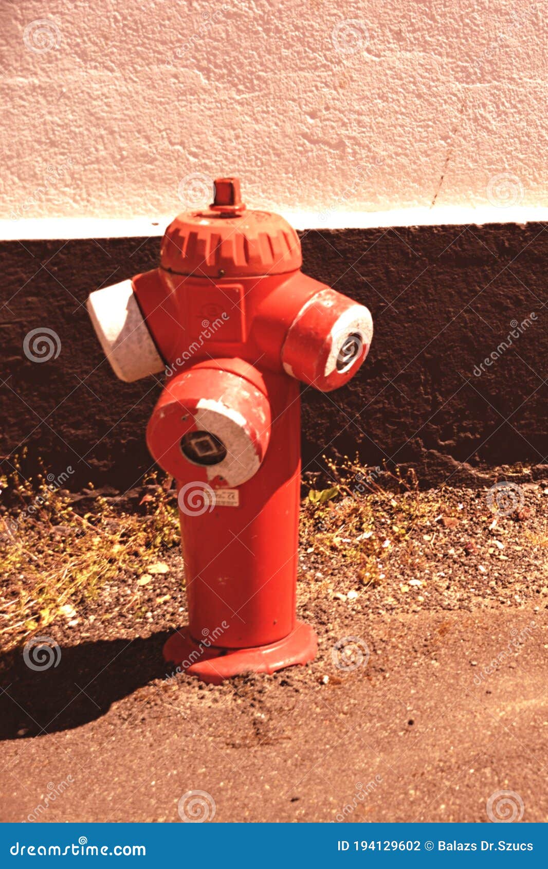 A Fire Hydrant Sitting on the Side of a Building Stock Photo - Image of ...
