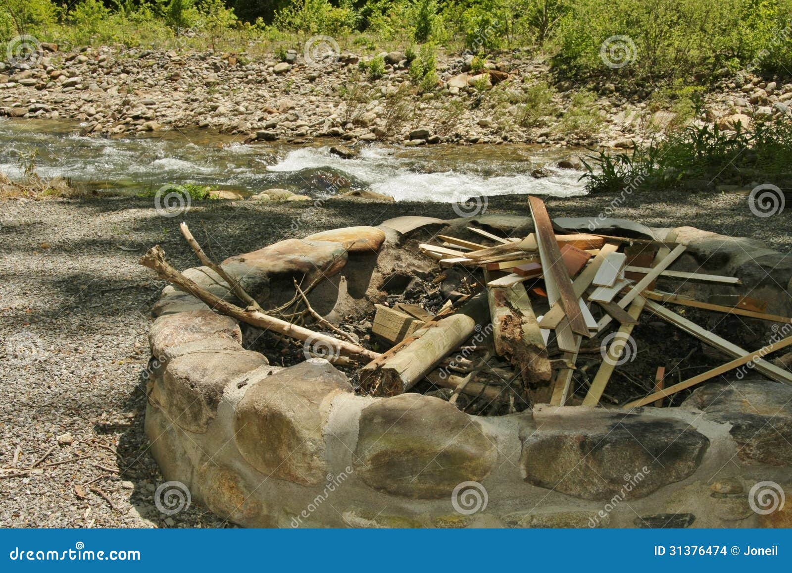 Fire Pit Near River Filled with Wood Stock Photo - Image of camping ...