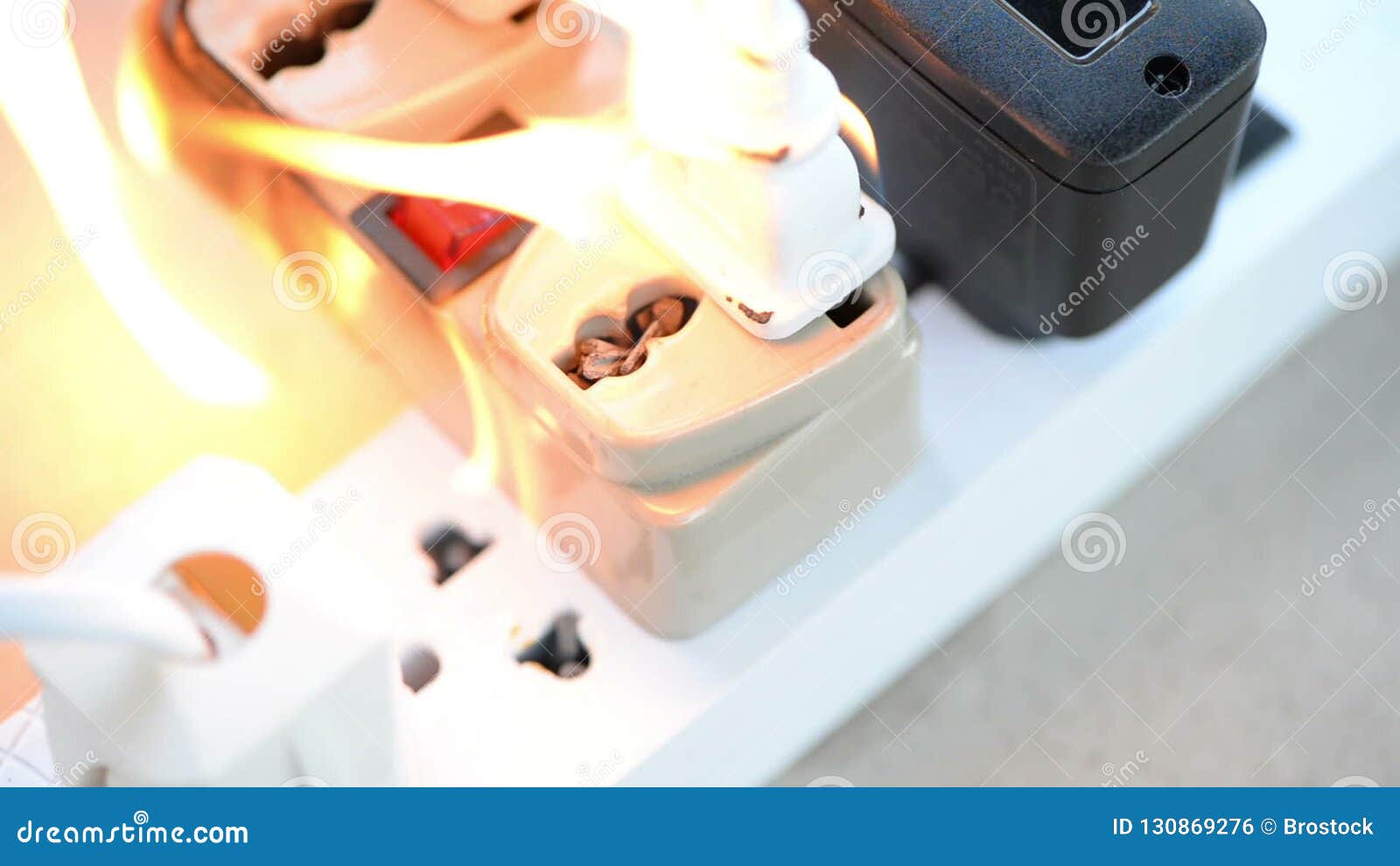 Fire from Plugging Power Cable into Overloaded Electric Outlet Stock ...