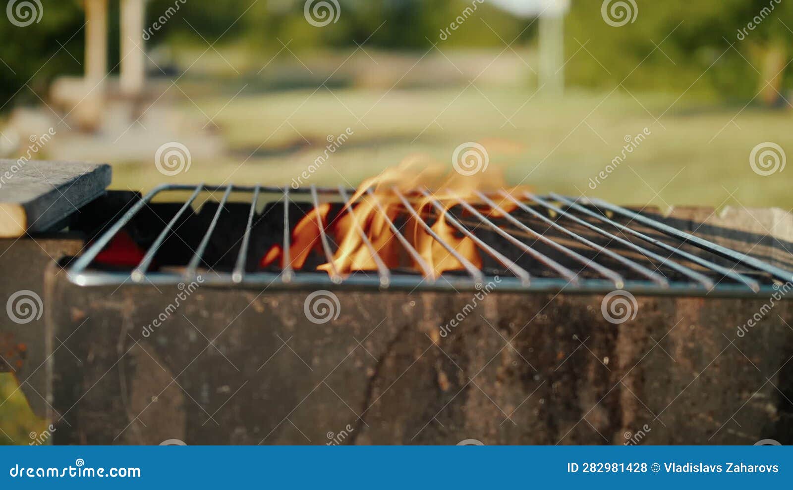 With the Fire Roaring Inside, the Grill Grate is Set on the Barbecue ...