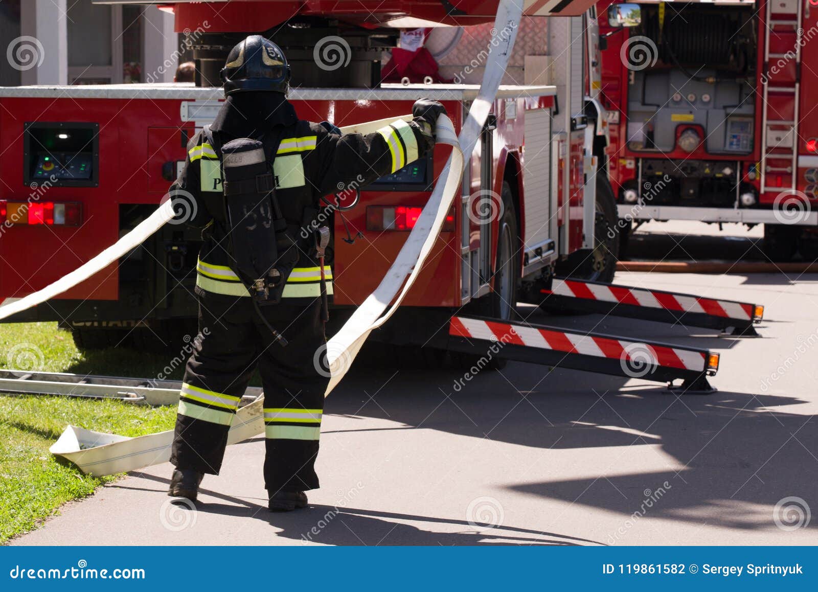 Fireman Unwinds the Hydrant Near the Fire Truck Editorial Photography ...